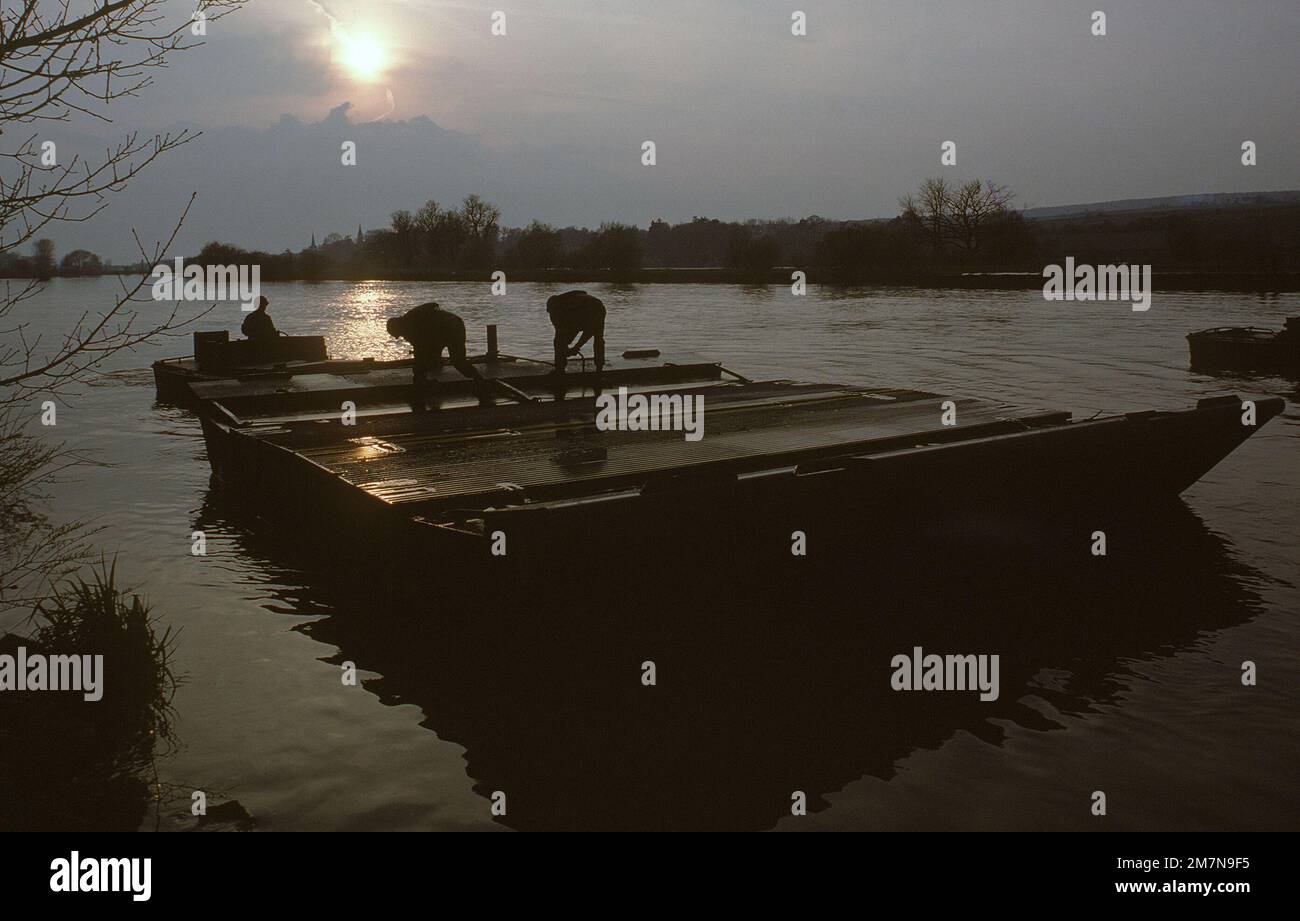 US Army soldiers maneuver a segment of floating bridge. Country ...