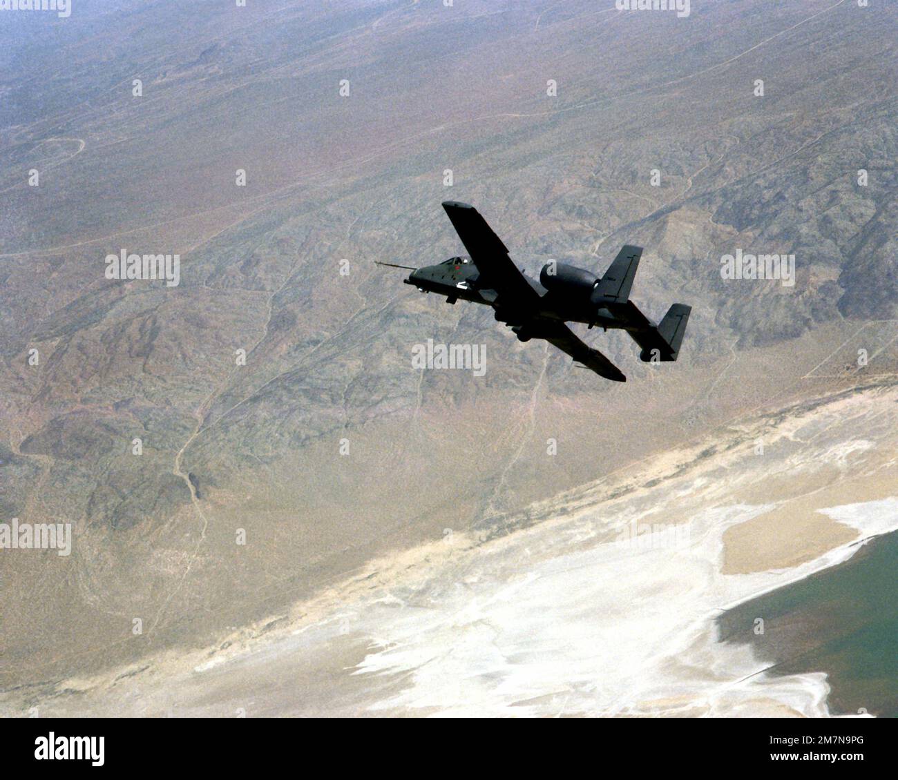 A left side view of an A-10 Thunderbolt II aircraft banking to the ...
