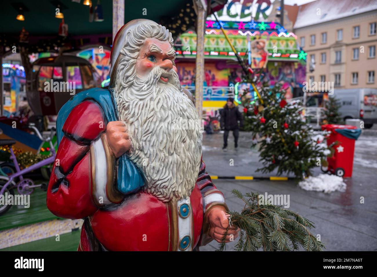 Santa Claus figure in front of a carousel at a Christmas market on the ...