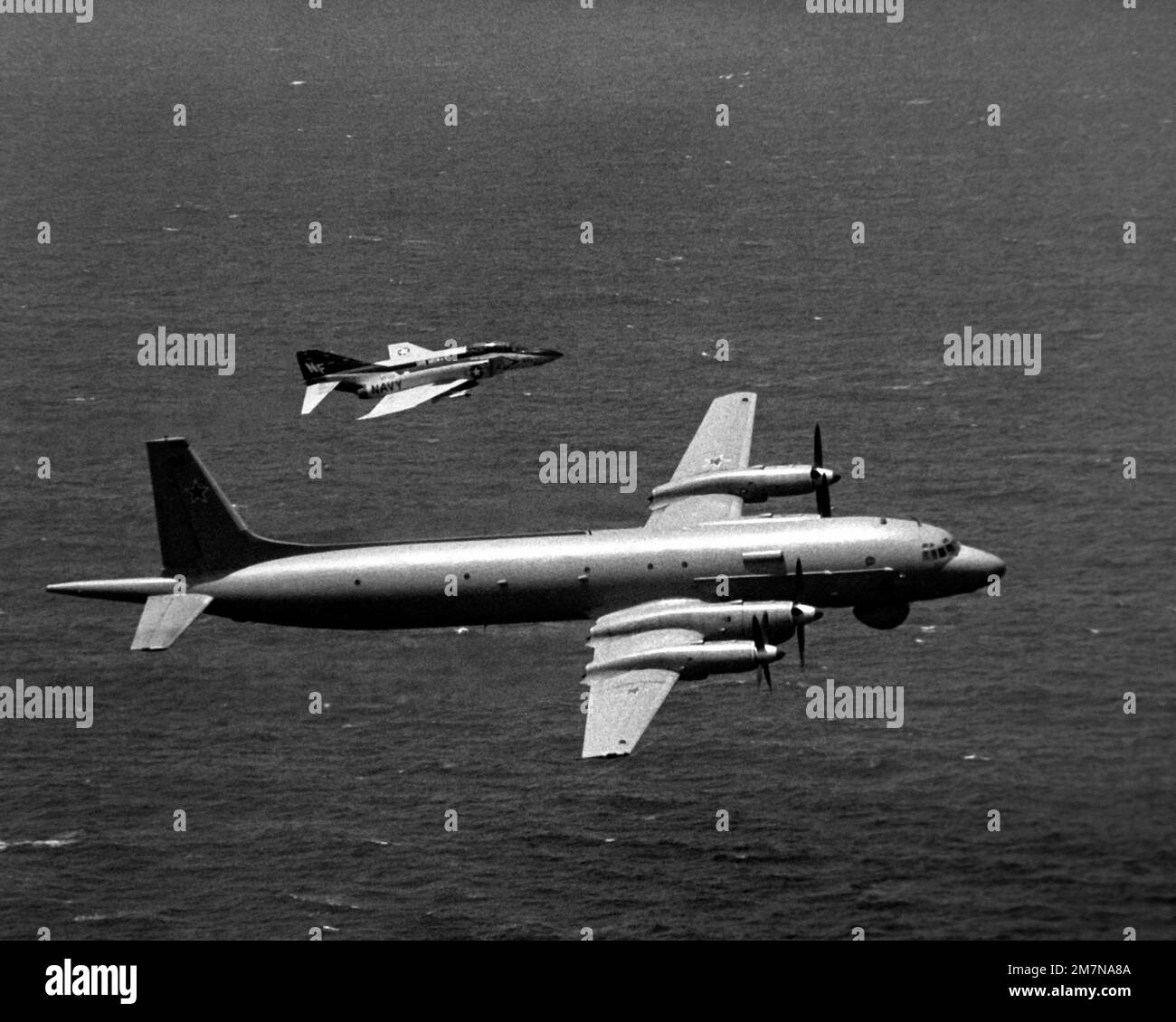 An air-to-air right side view of an F-4J Phantom II aircraft from ...