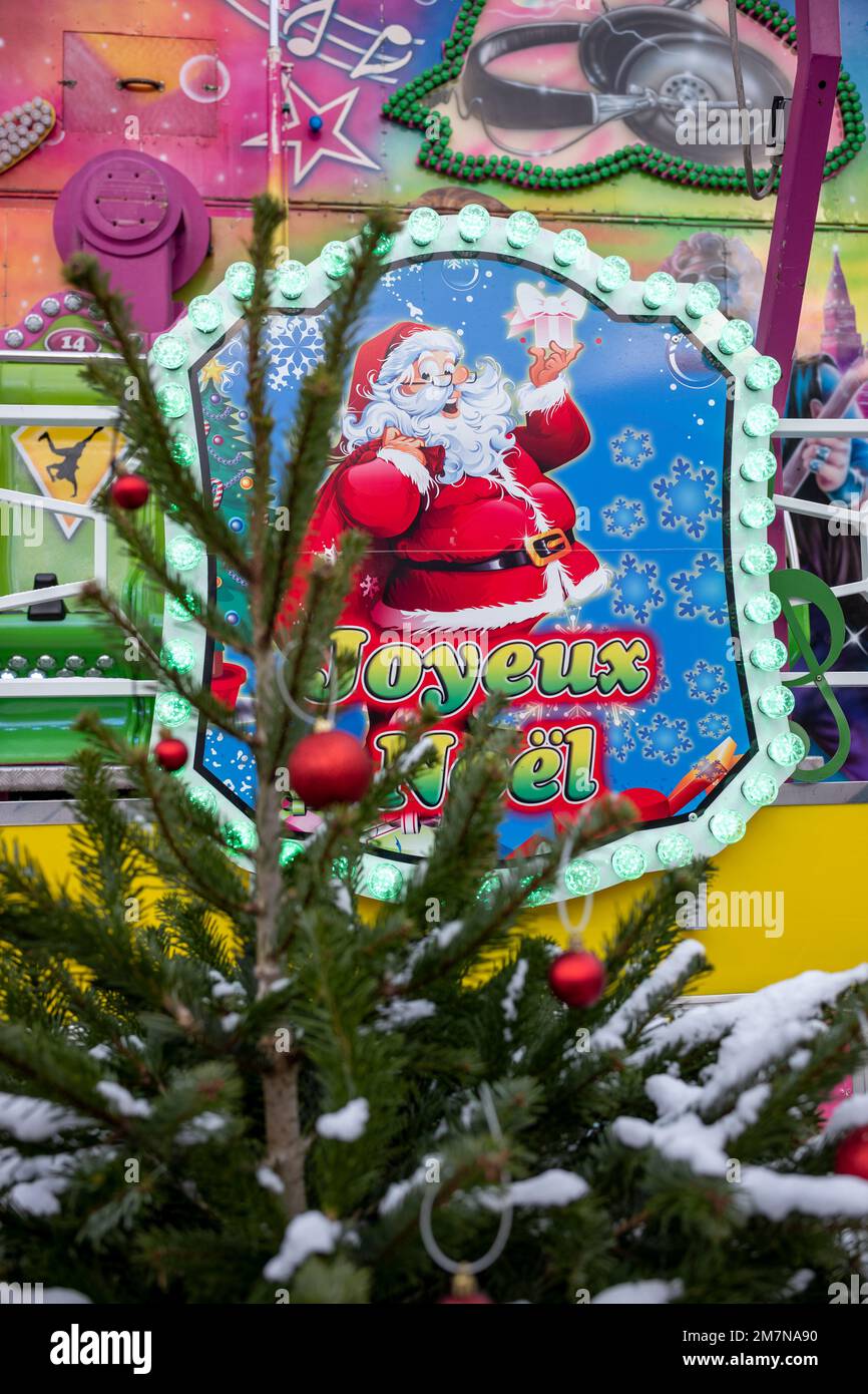 Sign with a Santa Claus on a carousel at a Christmas market on the day ...