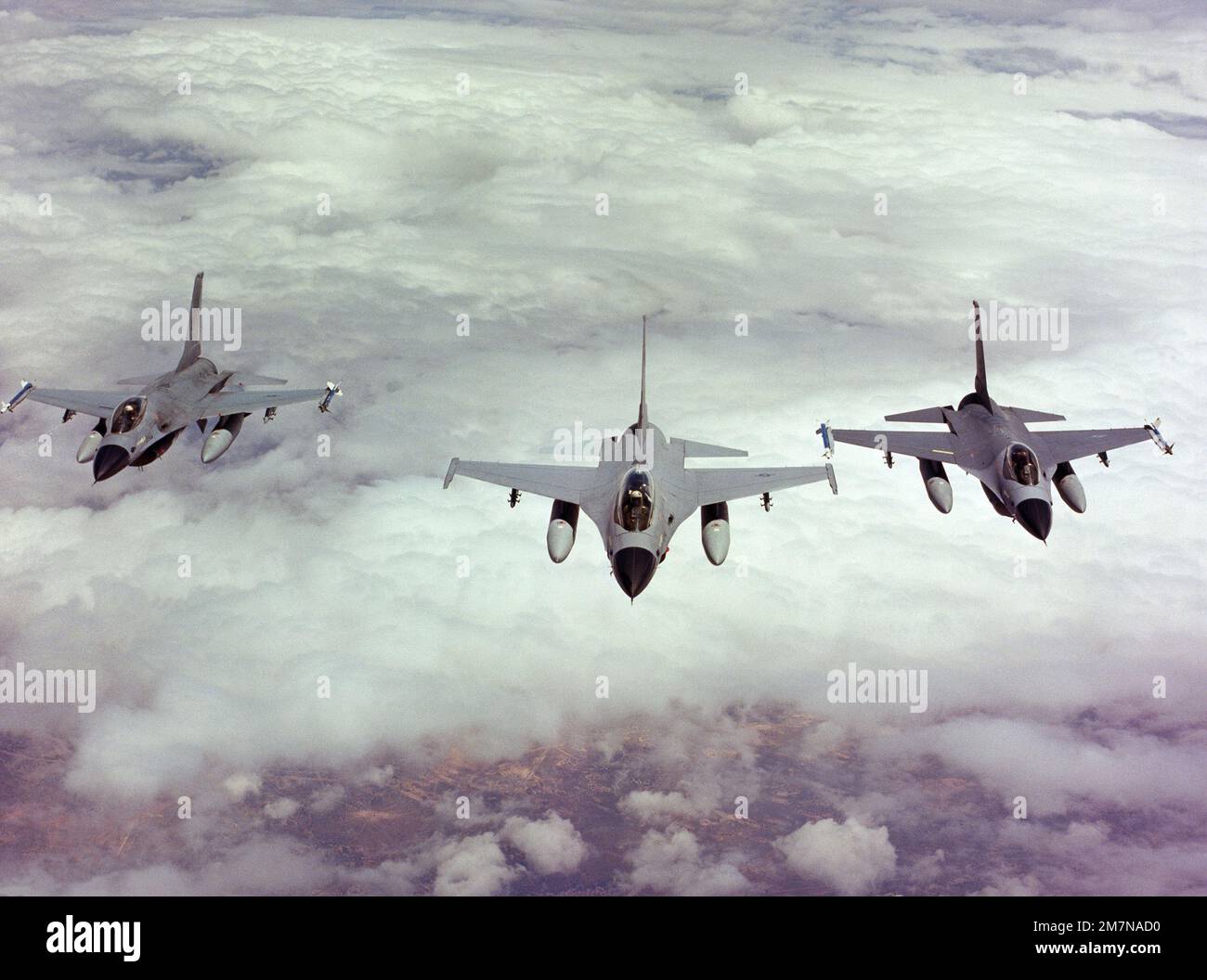 An air-to-air front view of three F-16 Fighting Falcon aircraft in ...