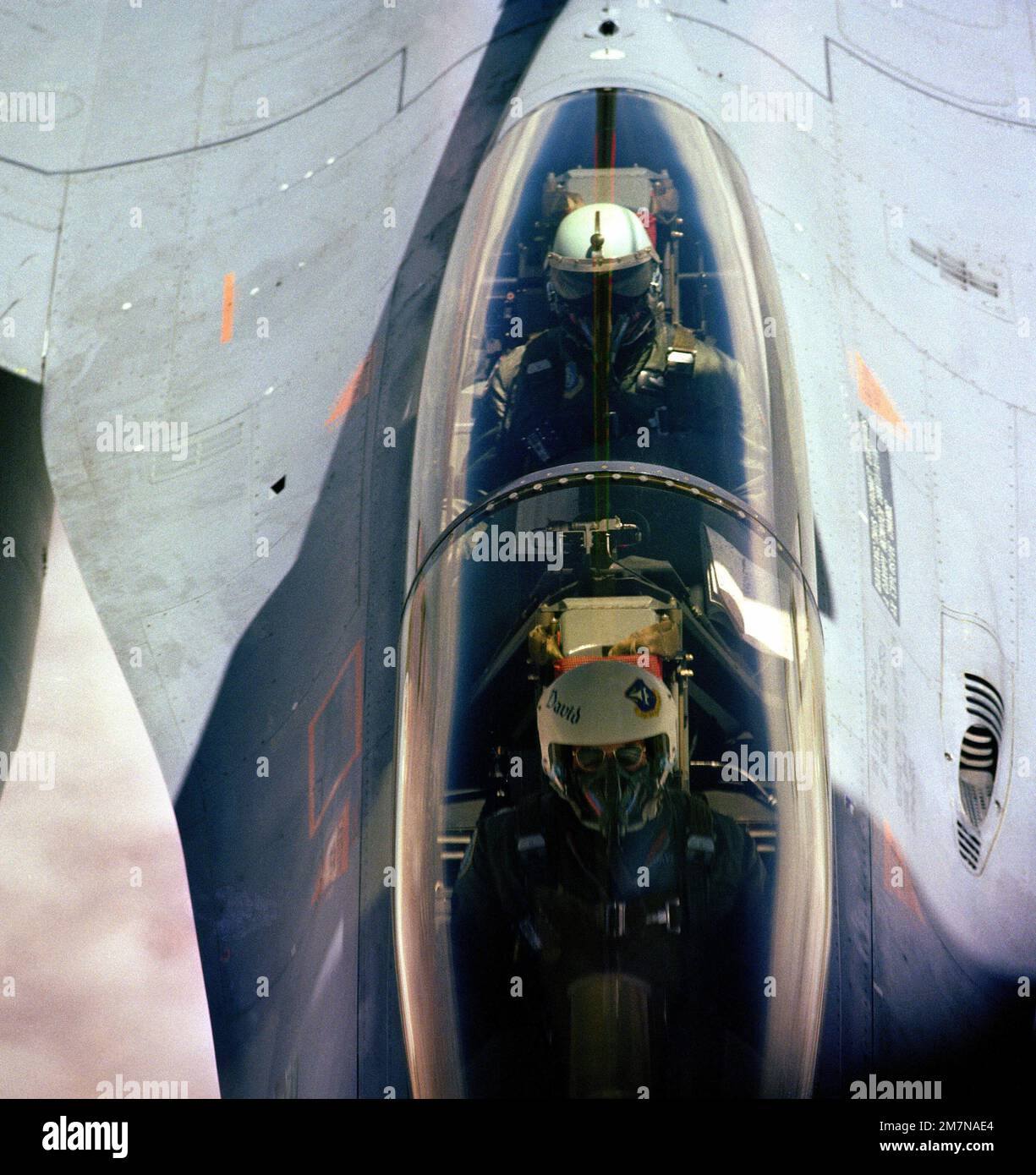 An overhead air-to-air close-up view of the tandem cockpit of an F-16B ...