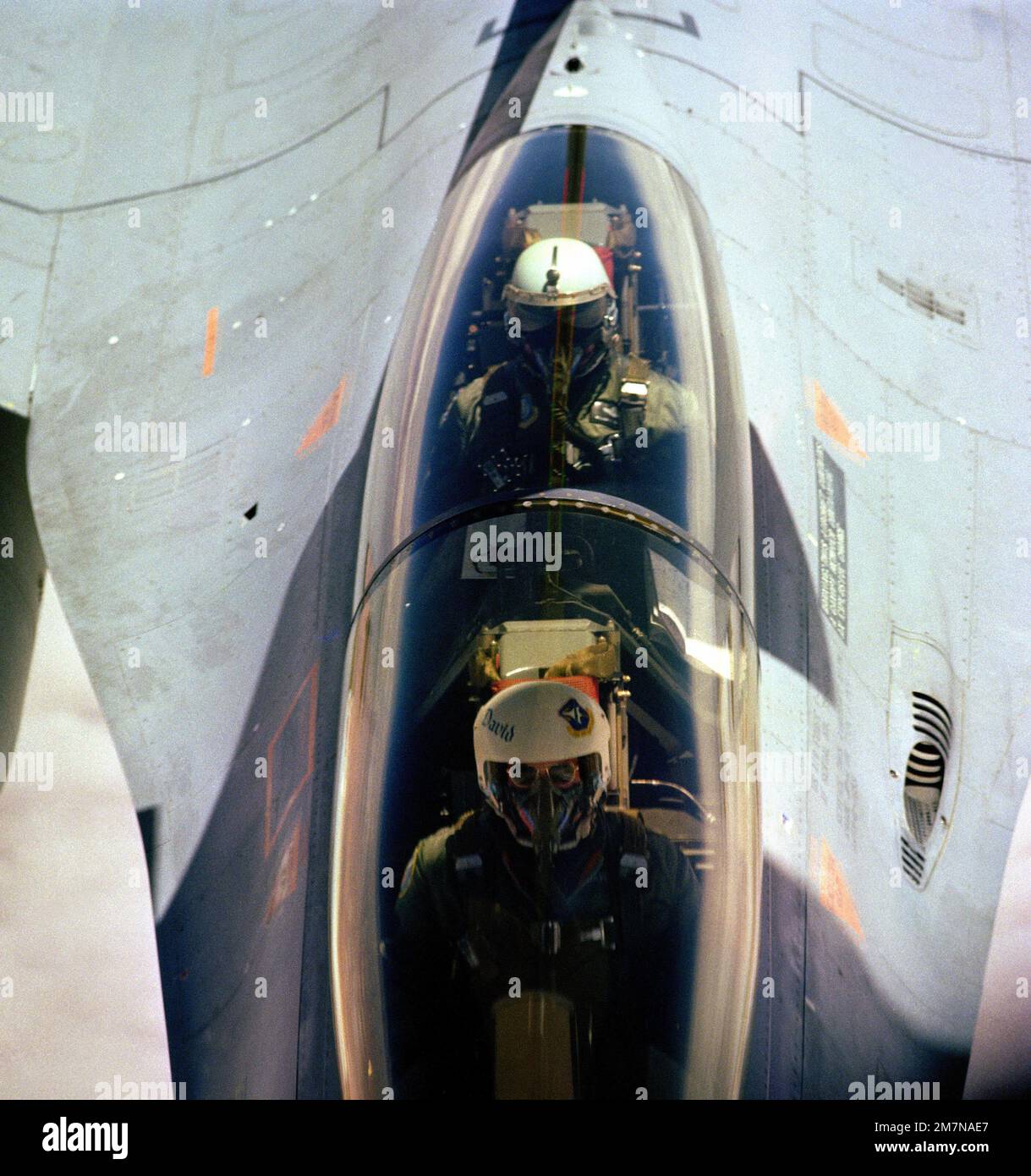 An overhead air-to-air close-up view of the tandem cockpit of an F-16B ...