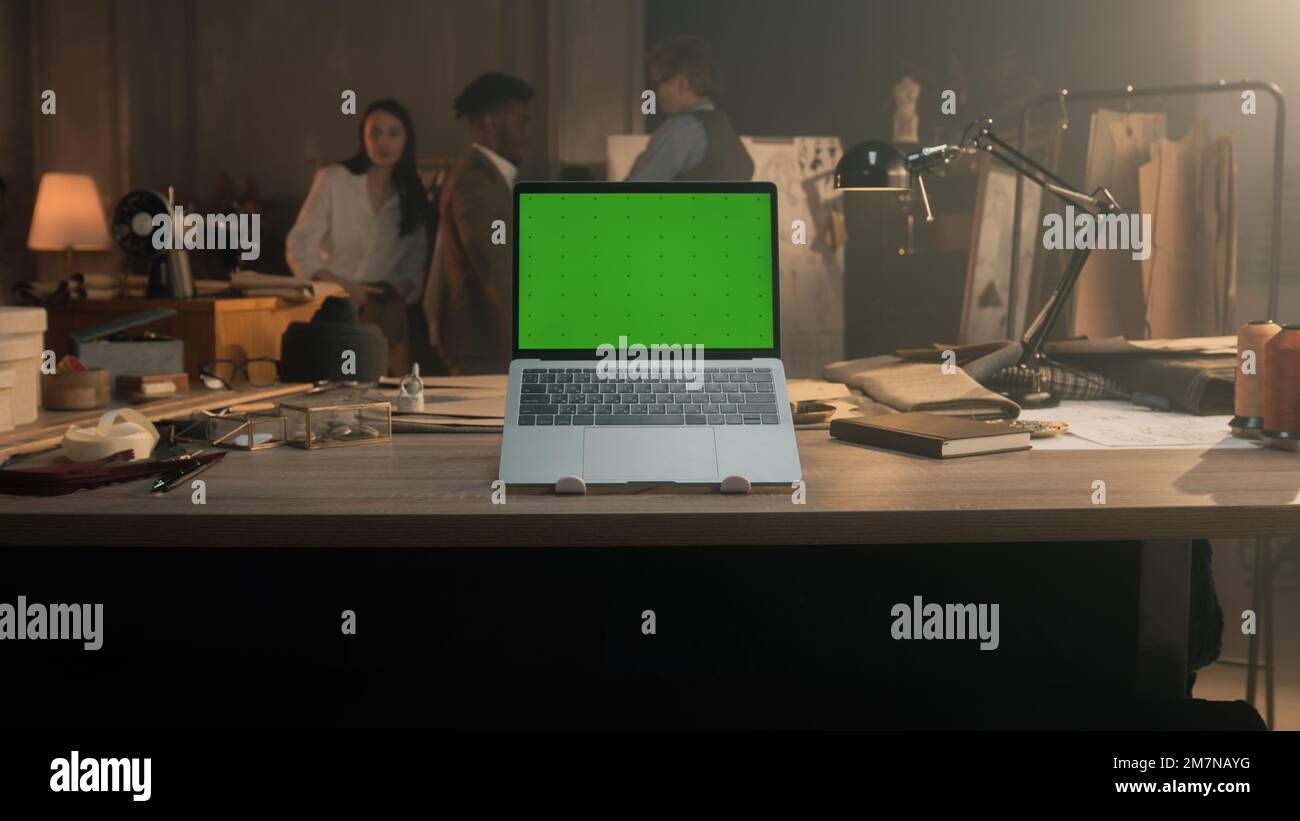 Cinematic shot of laptop with chromakey standing on table with ...