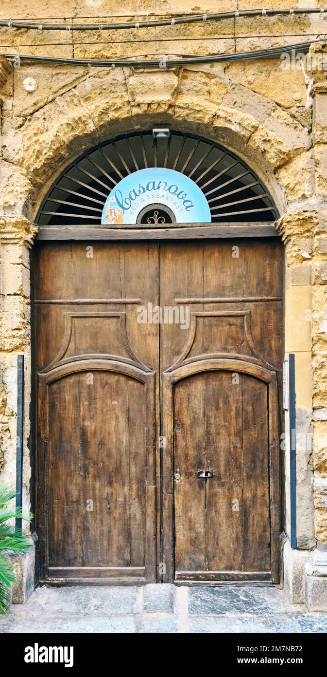 double wooden door in an archway made of quarry stones, Hotel Casanova ...