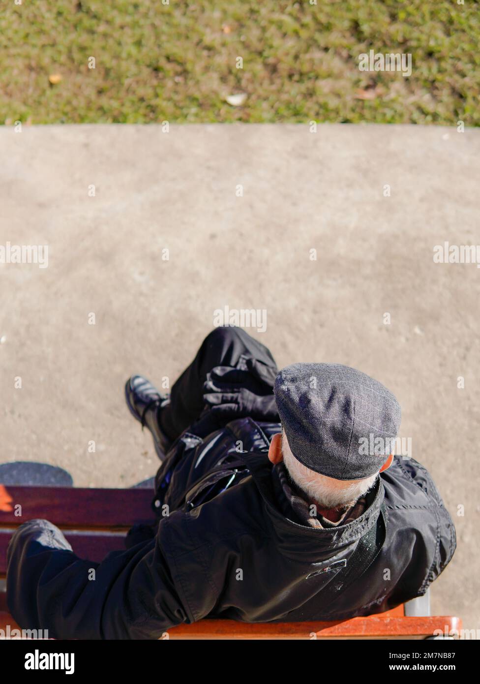 calm older gentleman sitting on a bench in the street. Old age in ...
