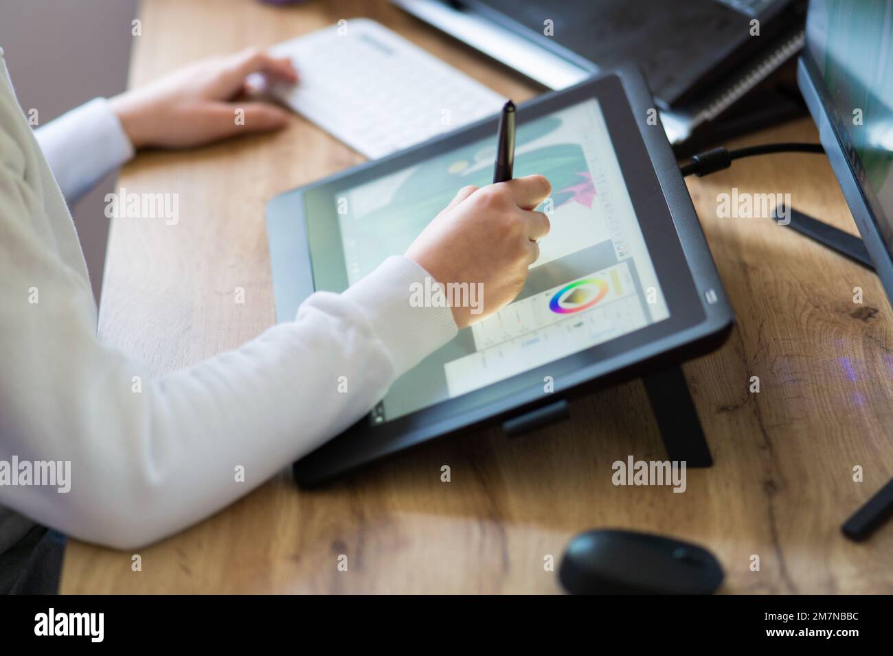 Young woman drawing on a digital tablet. Girl working from home as a ...