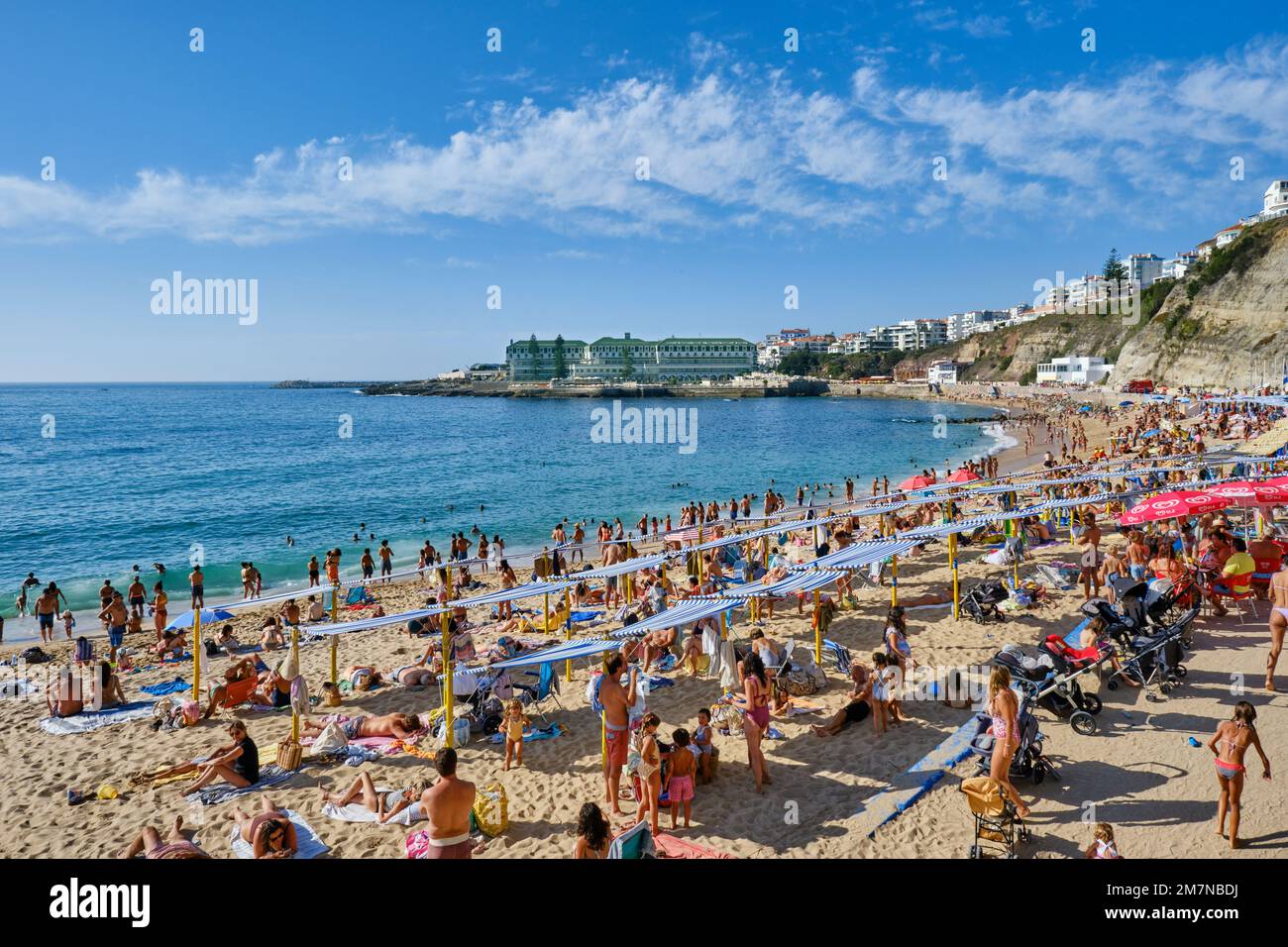 The overcrowded beach and village of Ericeira in August. Portugal Stock ...