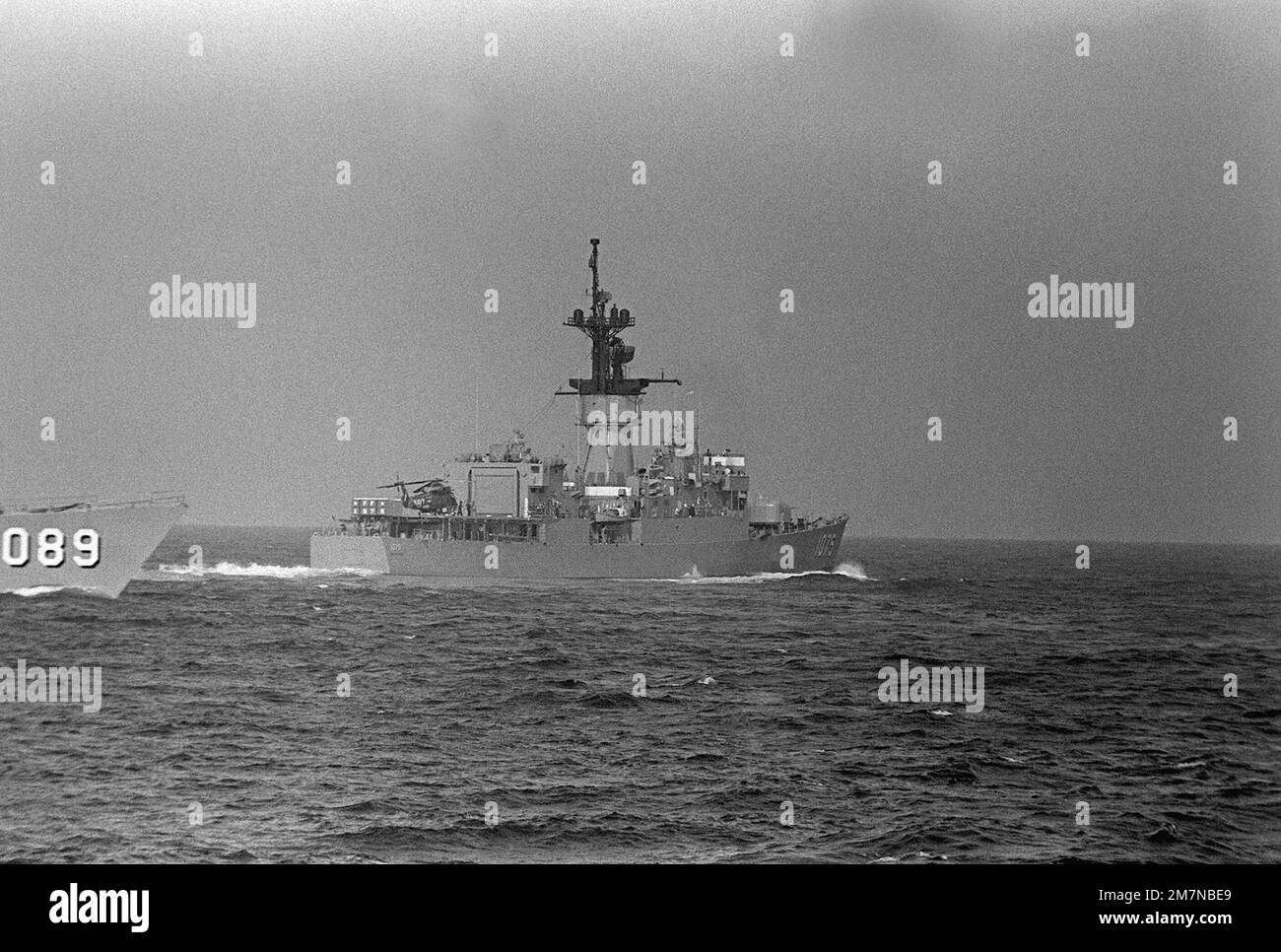 A starboard quarter view of the frigate USS TRIPPE (FF-1075) and a ...