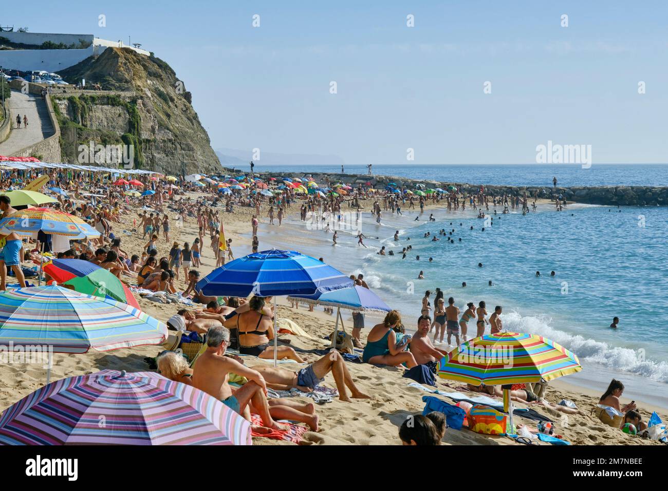 The overcrowded beach and village of Ericeira in August. Portugal Stock ...
