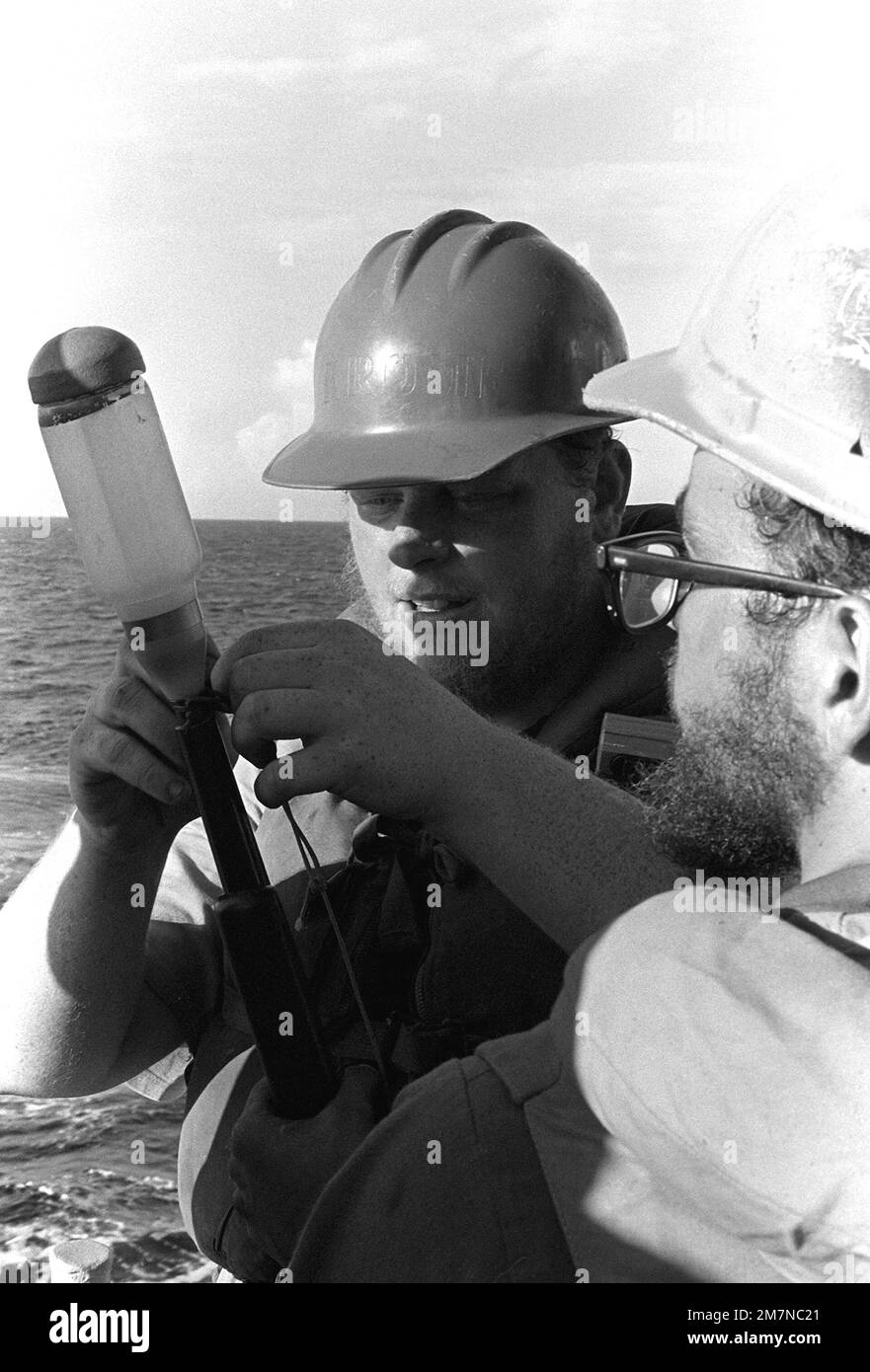 A crewman aboard the guided missile destroyer USS DEWEY (DDG-45 ...