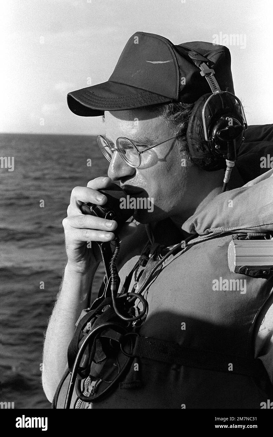 A radioman aboard the guided missile destroyer USS DEWEY (DDG-45 ...