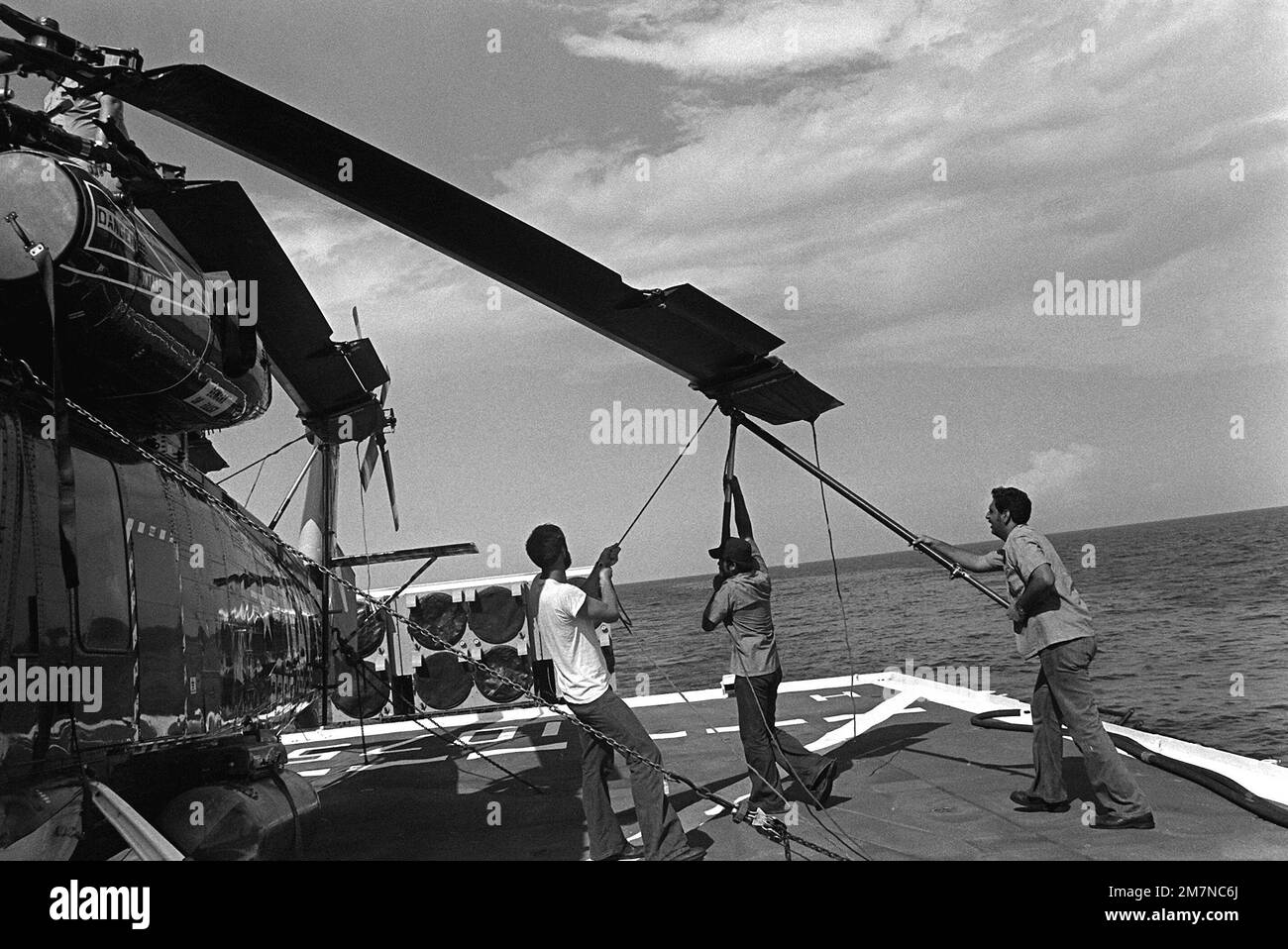 Crewmen aboard the frigate USS TRIPPE (FF-1075) work on an SH-2D ...
