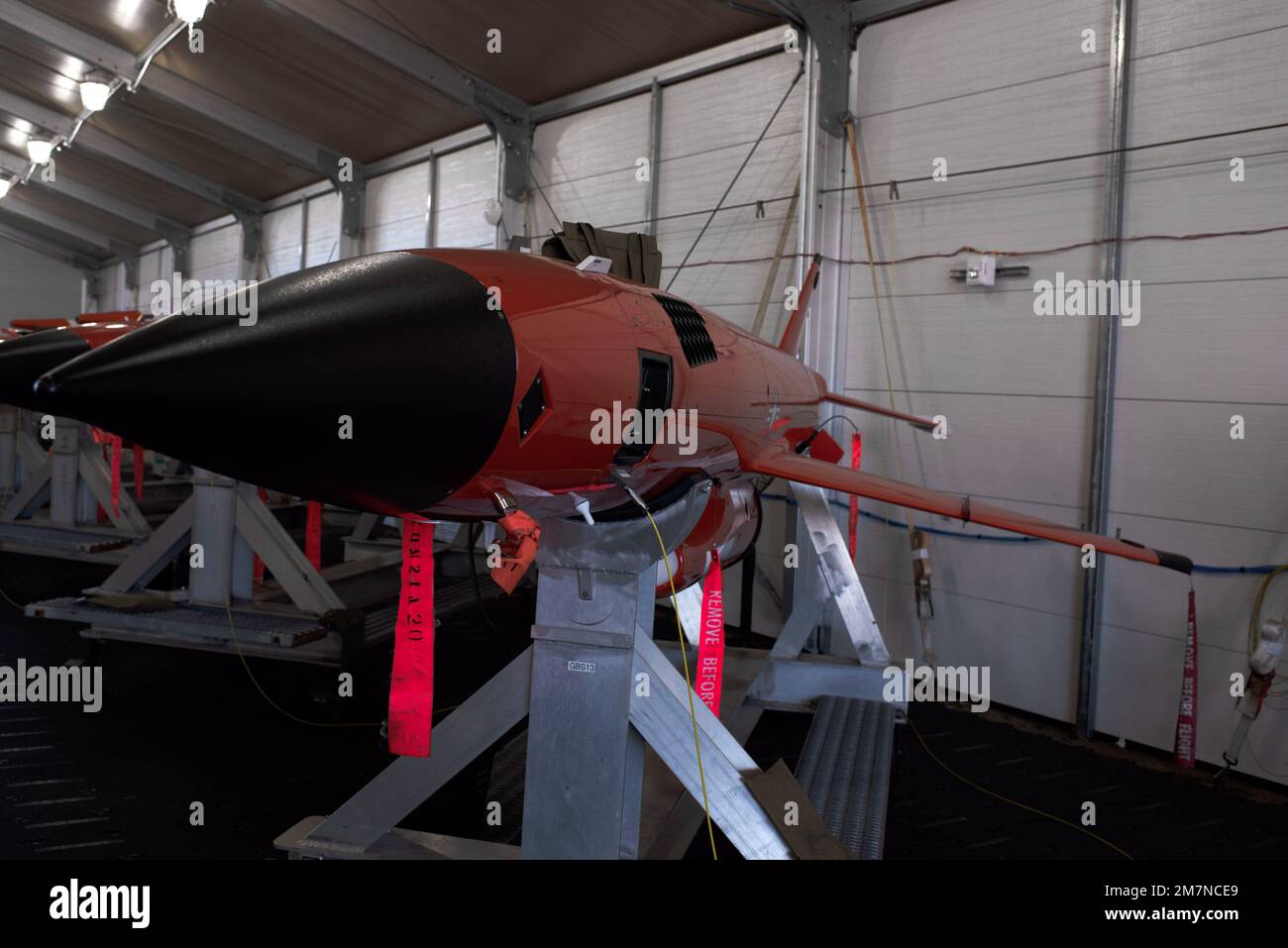 A BQM-167A sub-scale aerial target drone is housed in a hangar during ...