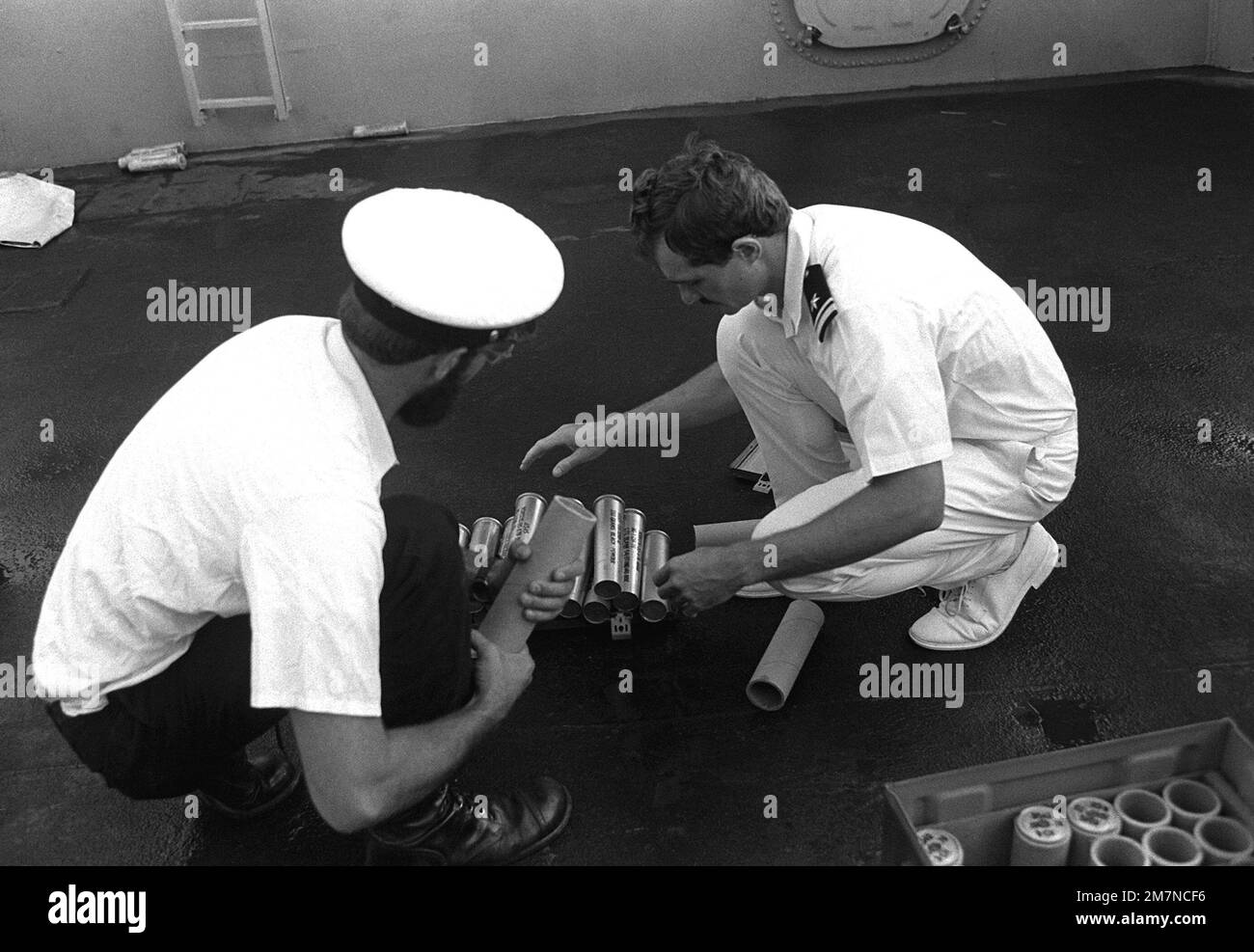 An officer and crewman on board the guided missile destroyer USS DEWEY ...