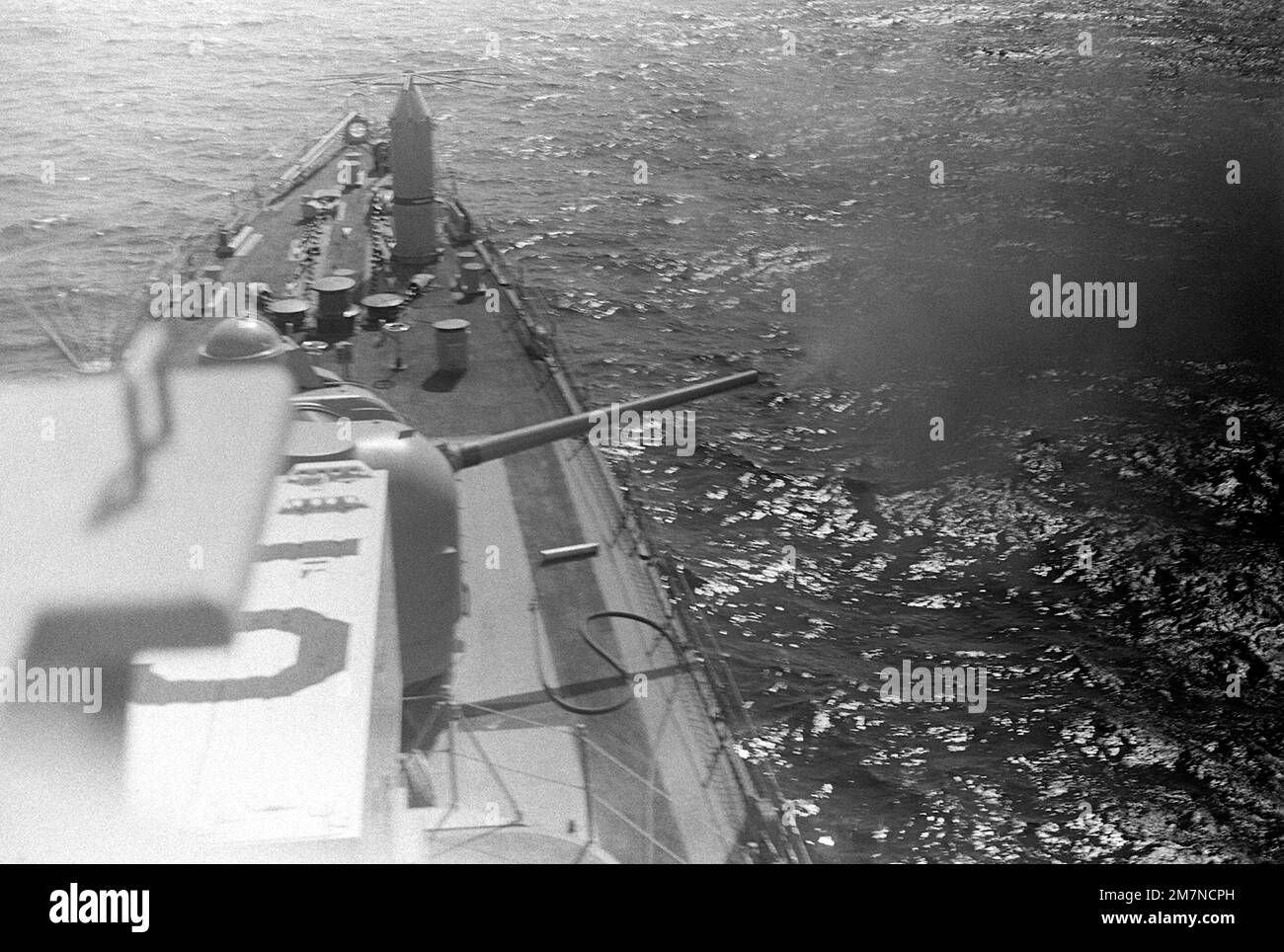 A Mark 42 5-inch/54 caliber gun is fired from the guided missile ...