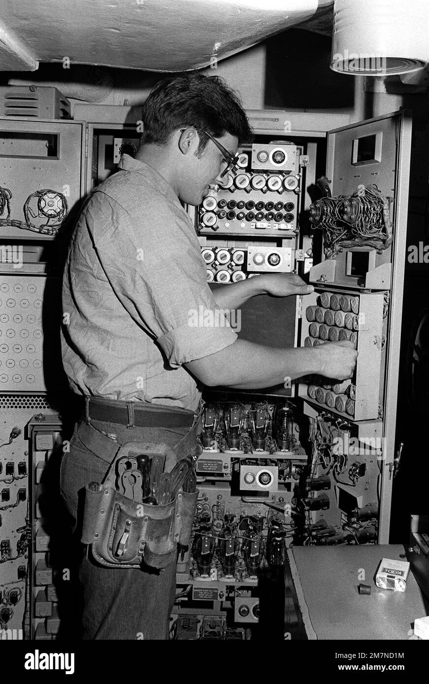 An interior communications electrician (IC) works on electrical ...