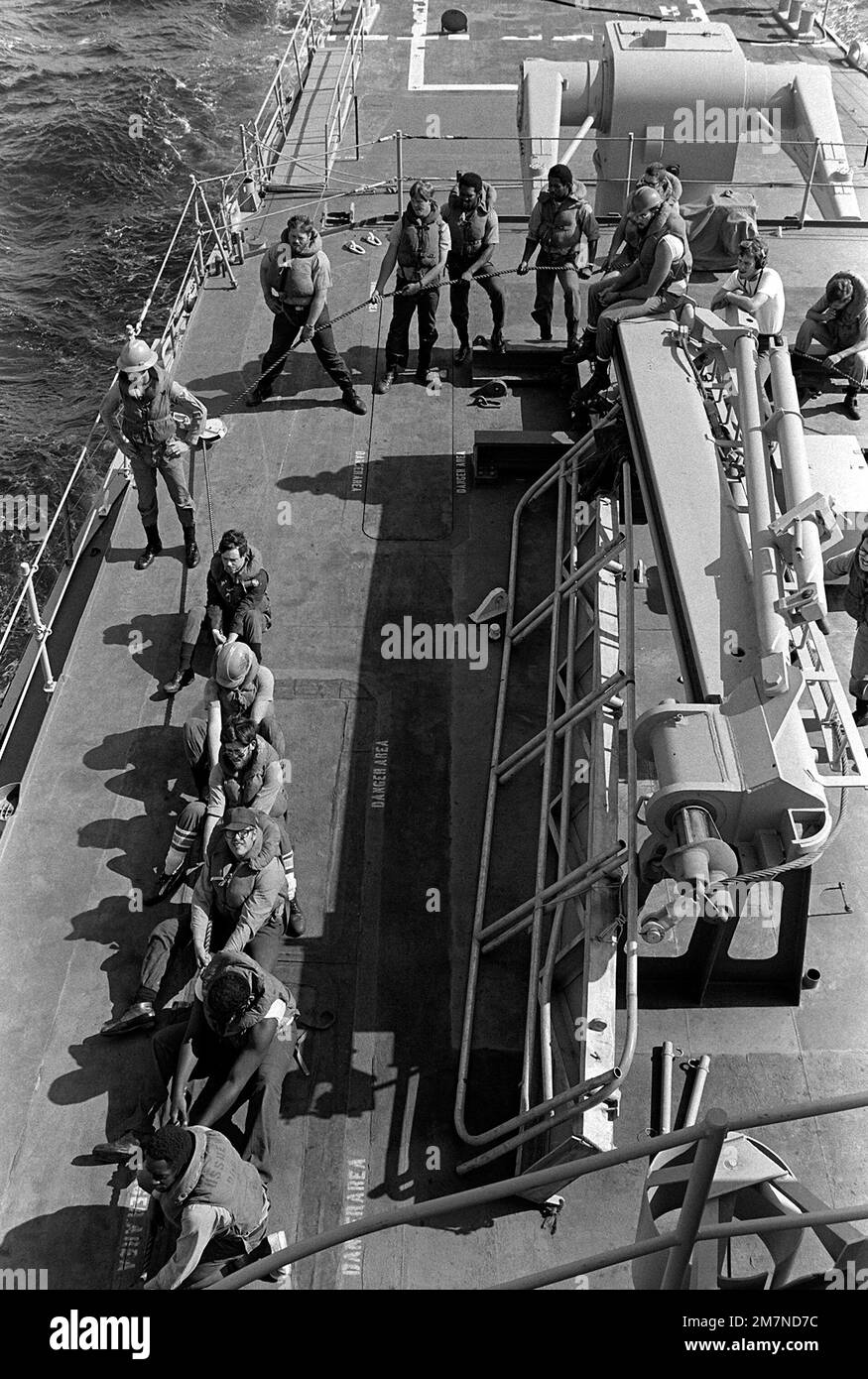 Crewmen aboard the guided missile destroyer USS DEWEY (DDG-45) man ...