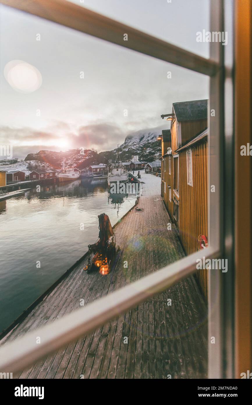Nusfjord, window with view outside, sun rays, fishing village, Lofoten ...