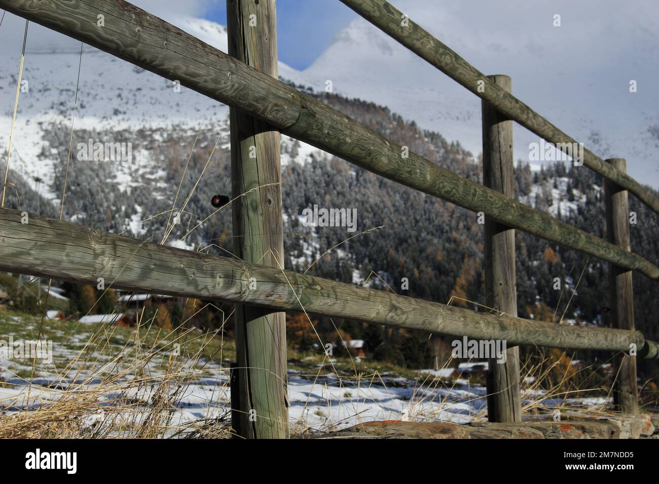 Parallel natural alpine style wooden fence with a view of the Swiss ...