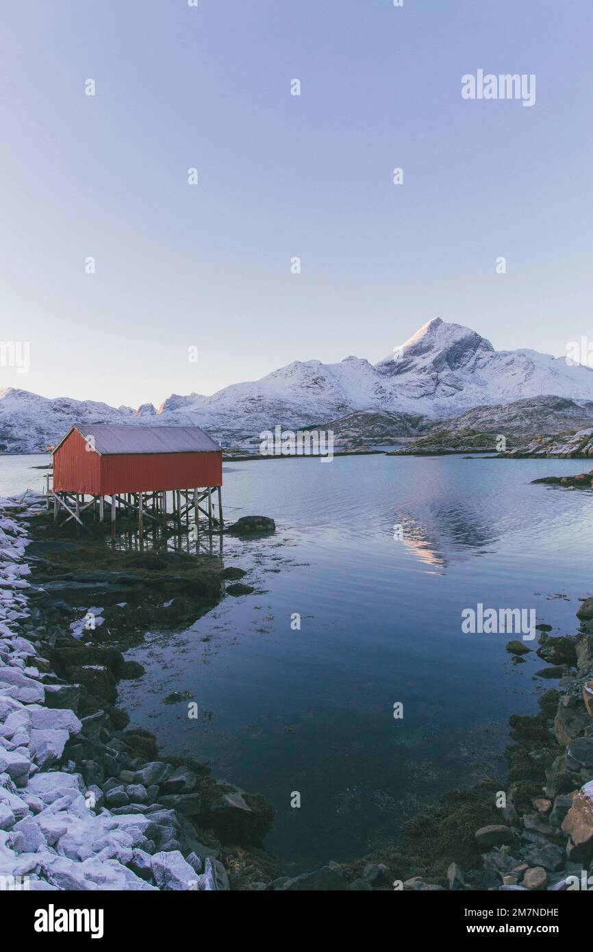 Traditional fishing hut on stilts, Norway, typical fjord landscape with ...
