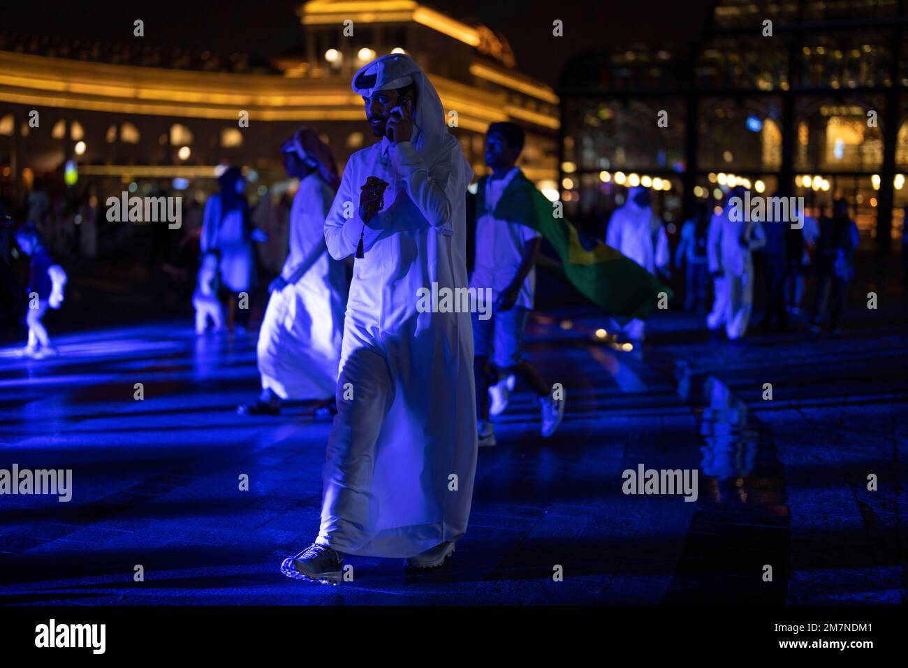 People walk along a commercial area in Doha, Qatar, Wednesday, Dec. 7 ...