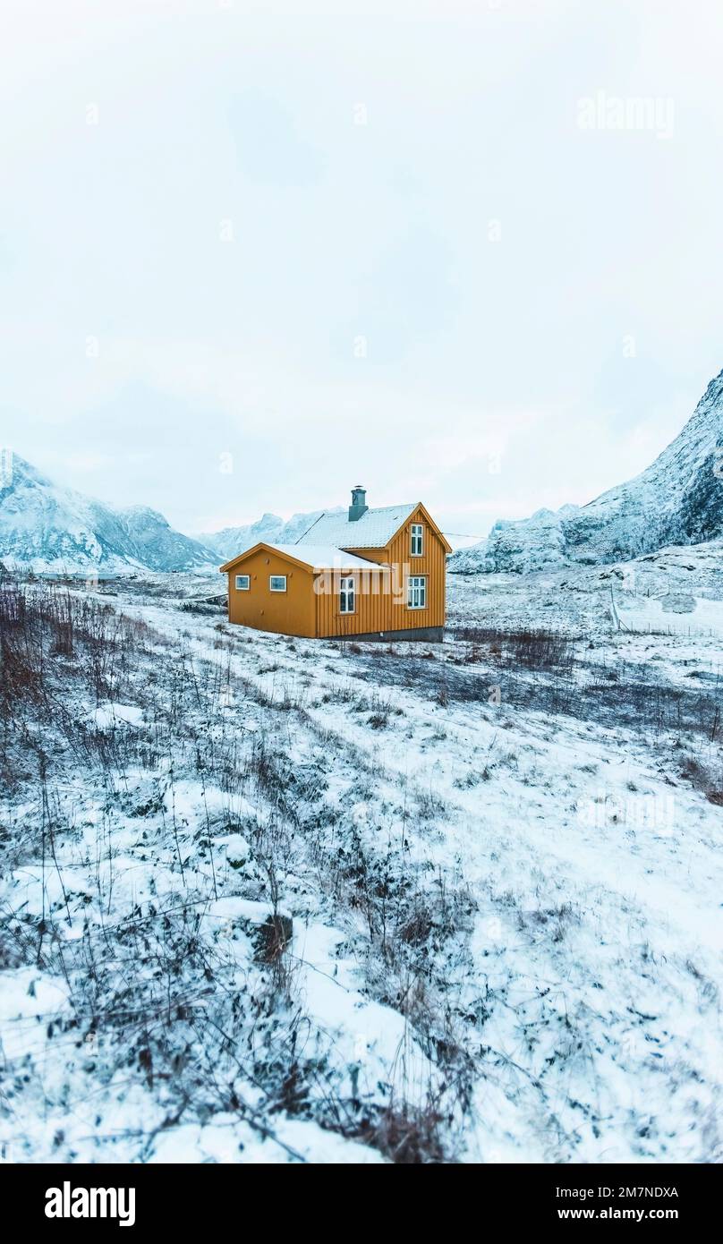 Lonely yellow house in the snowy landscape in Norway, old residential ...
