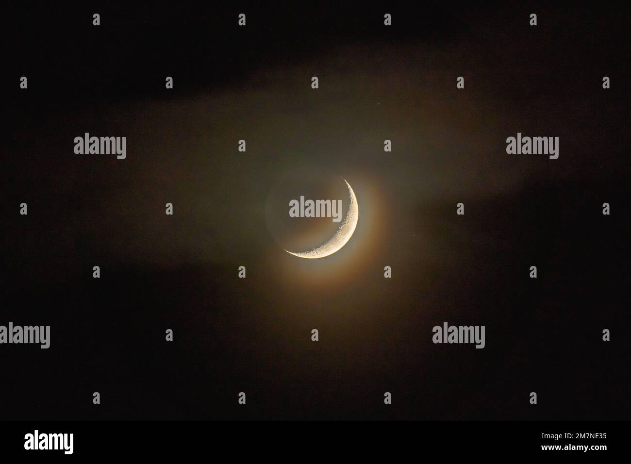 The waxing crescent phase of the moon shining brightly in the black ...