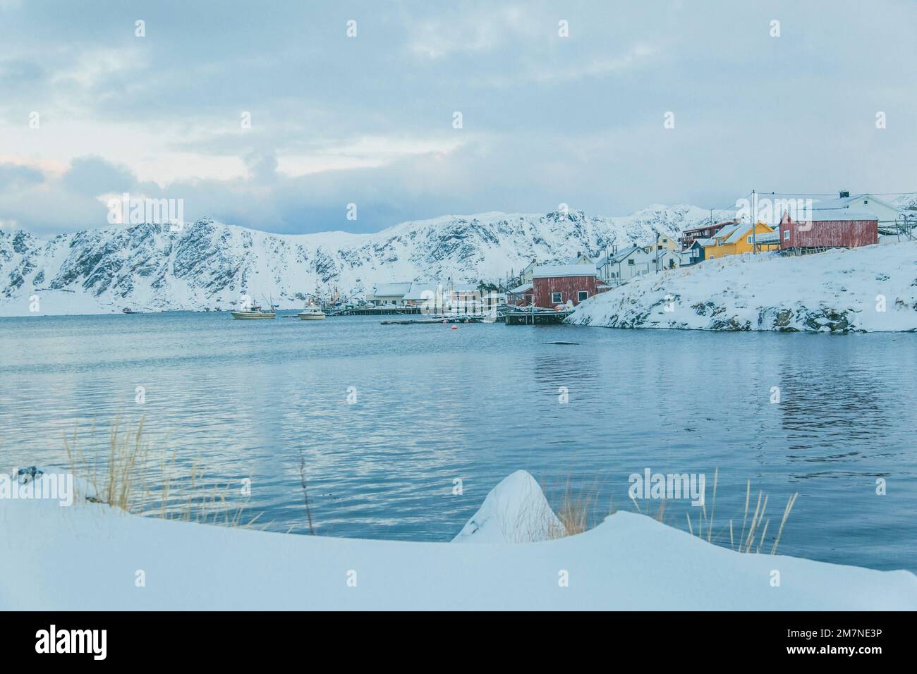 Lonely snowy fishing village on the fjord in Norway, typical fjord ...