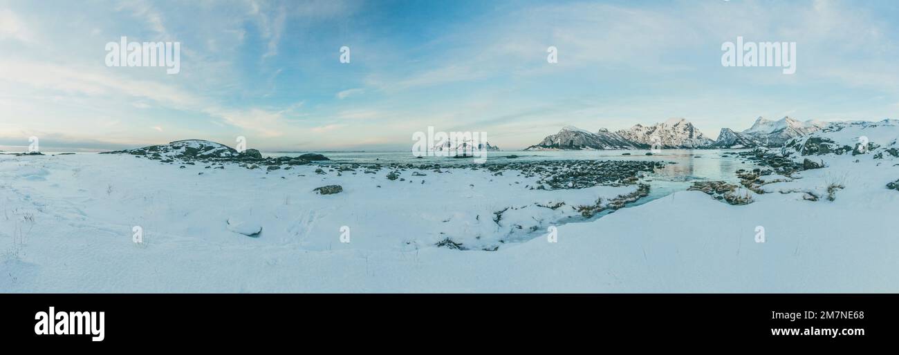 Snowy winter landscape on the rocky coast in Norway, panoramic image of ...