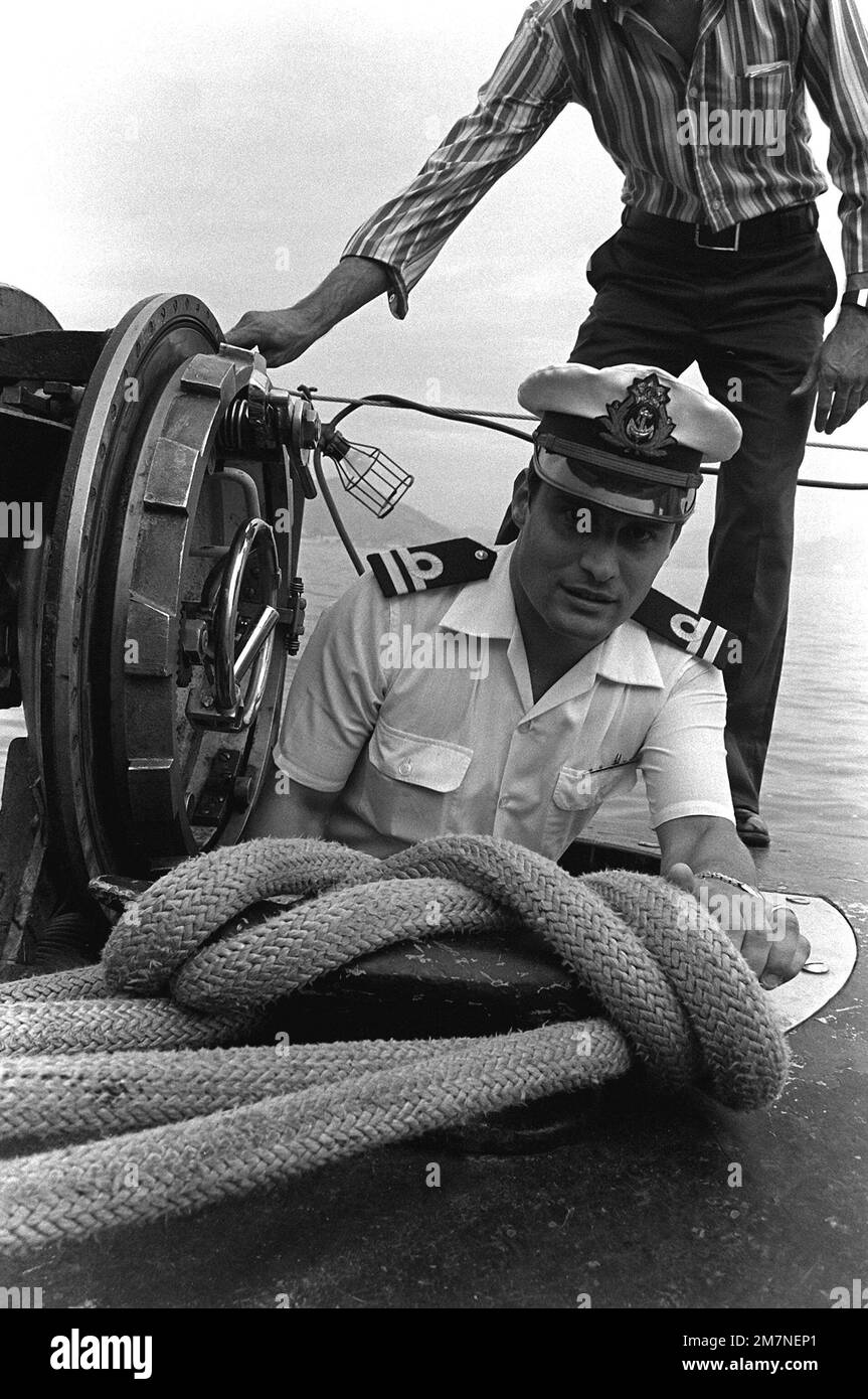A Brazilian naval officer enters the hatchway of a U.S. Navy attack ...