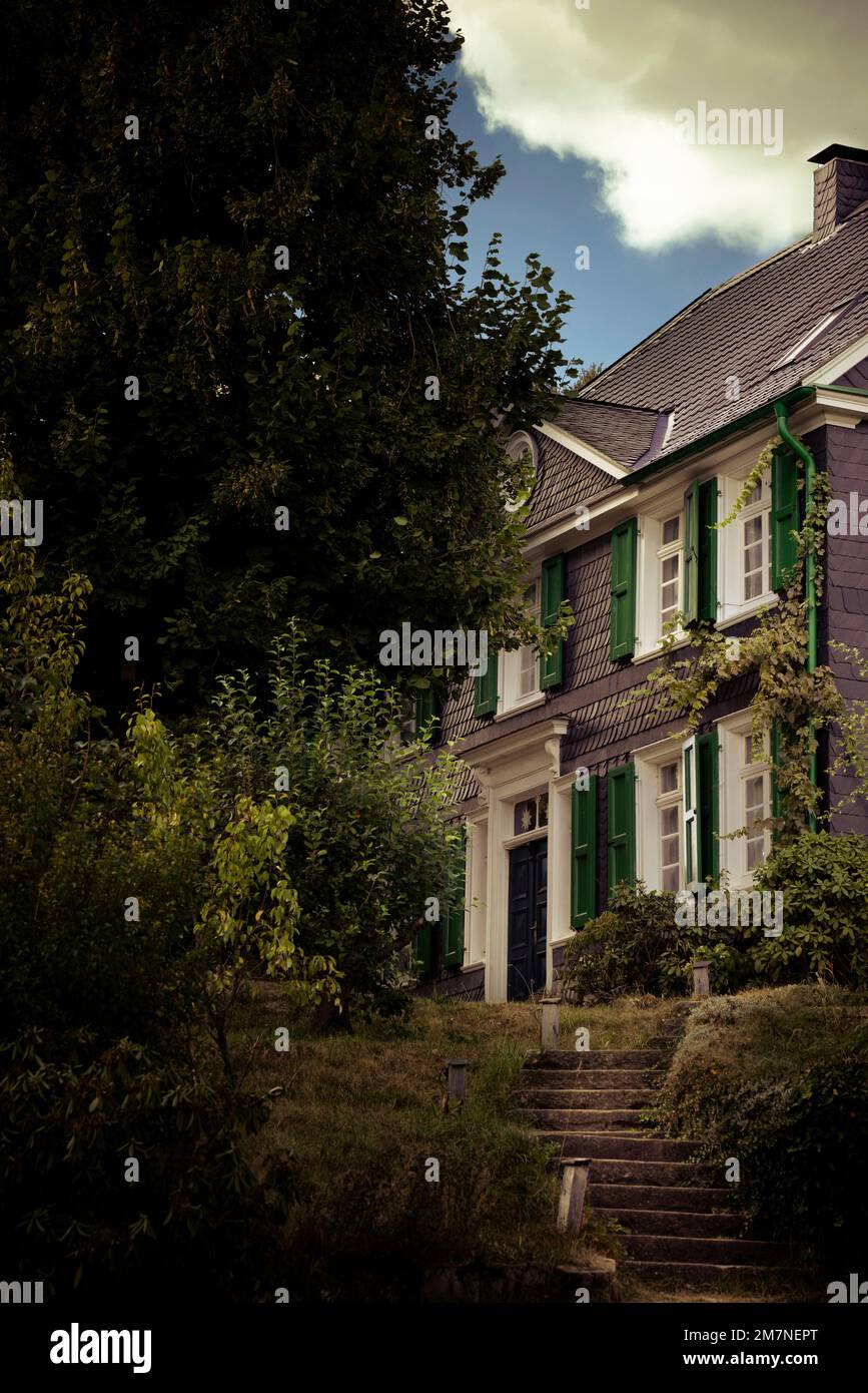 Part of a mountain slate house in the greenery Stock Photo - Alamy