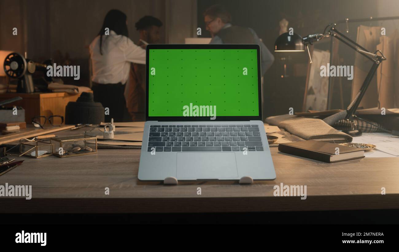 Cinematic shot of laptop with chromakey standing on table with ...