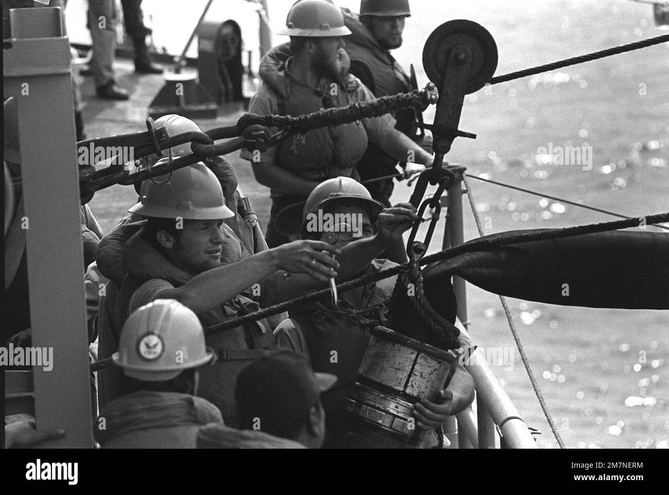 Crewmen aboard the guided missile destroyer USS DEWEY (DDG-45) prepare ...