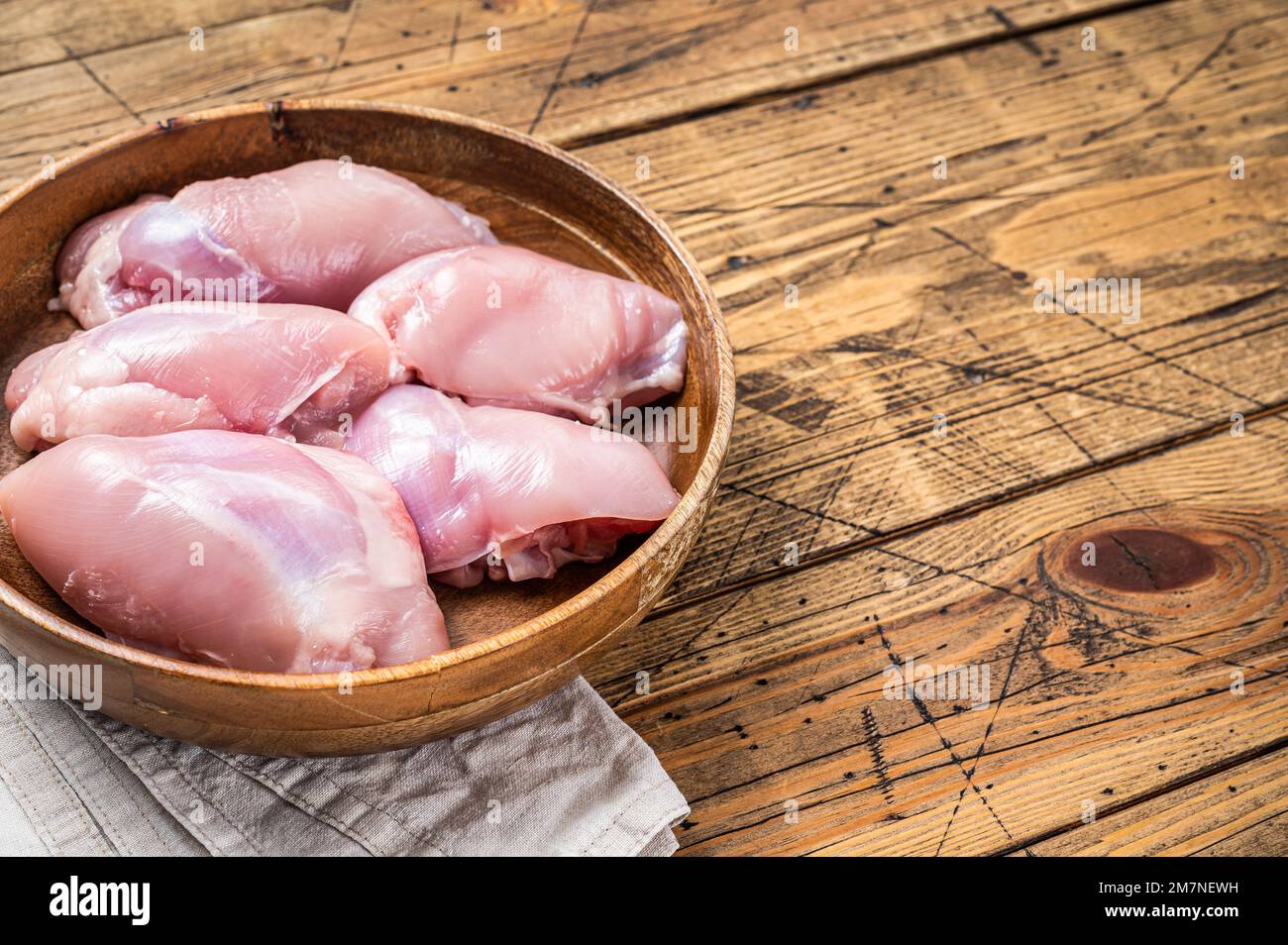 Fresh Chicken thigh meat, Raw Boneless and skinless fillet in a wooden ...