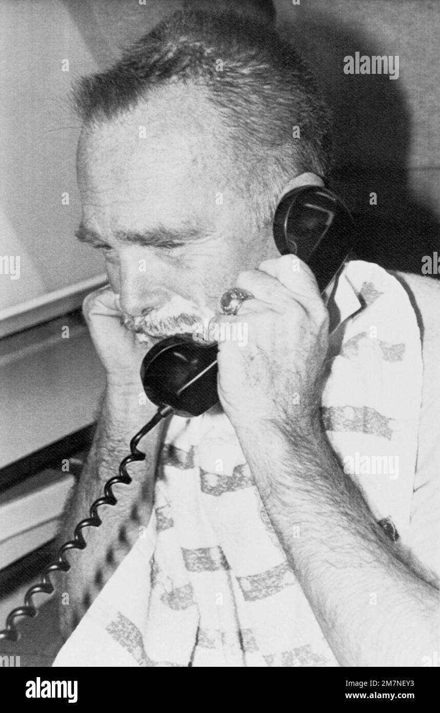 U.S. Brig. Gen. James Dozier pauses during a shave to talk by telephone ...
