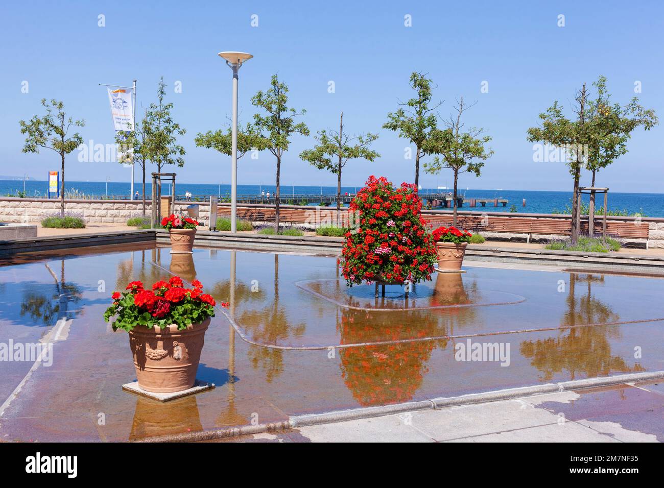 Fountain with flower pots on the beach promenade hi-res stock ...