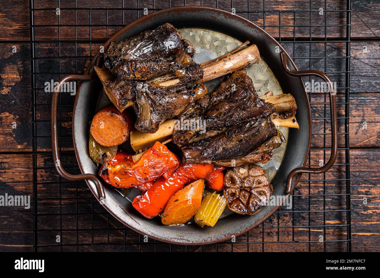 Homemade Braised Lamb Shanks with Sauce and Herbs in a steel tray ...