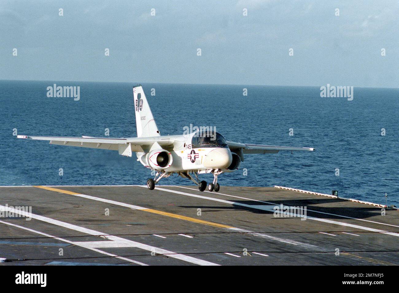 A right front view of an S-3 Viking aircraft landing on the flight deck ...
