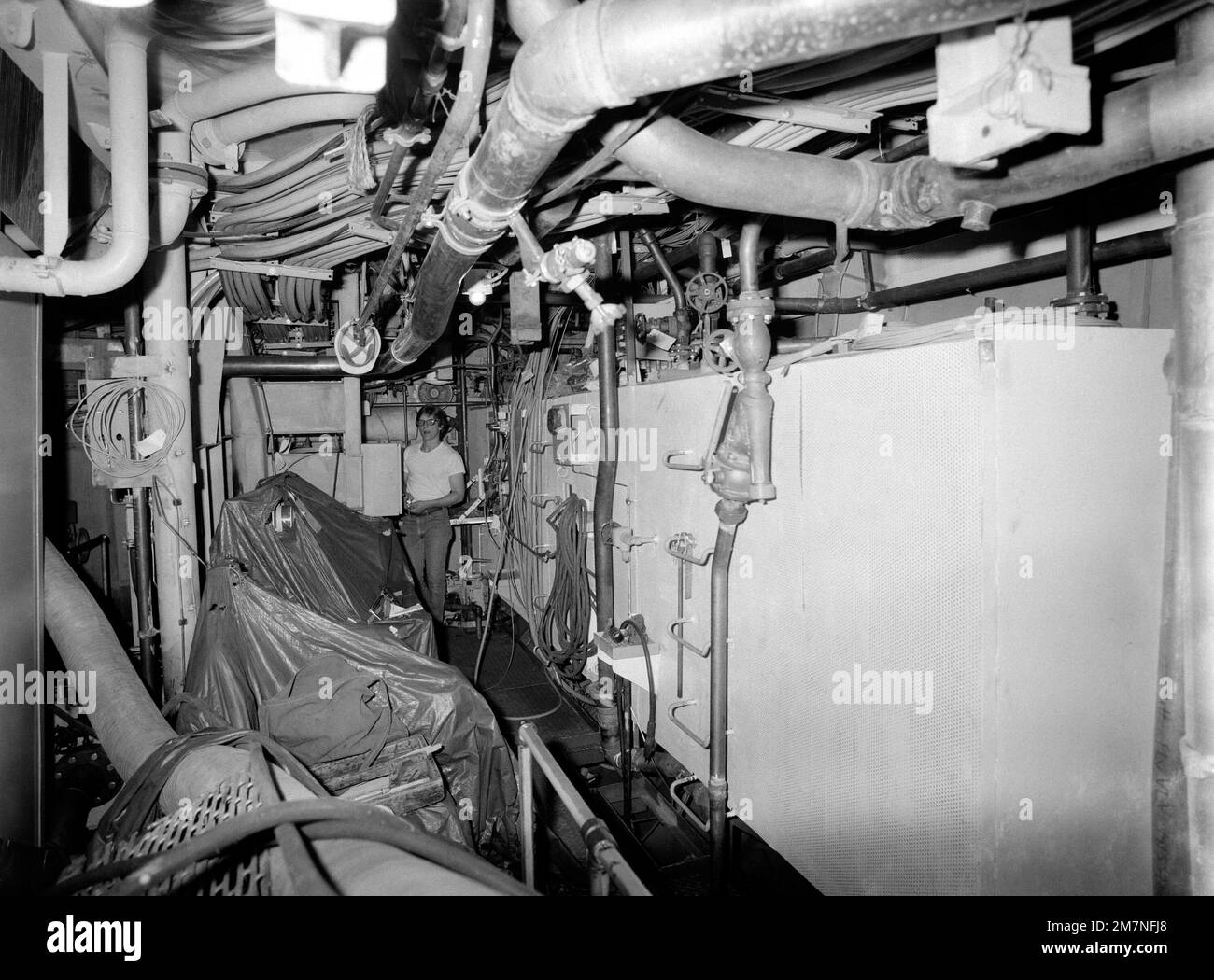An interior view of the engine room on the guided missile frigate USS ...
