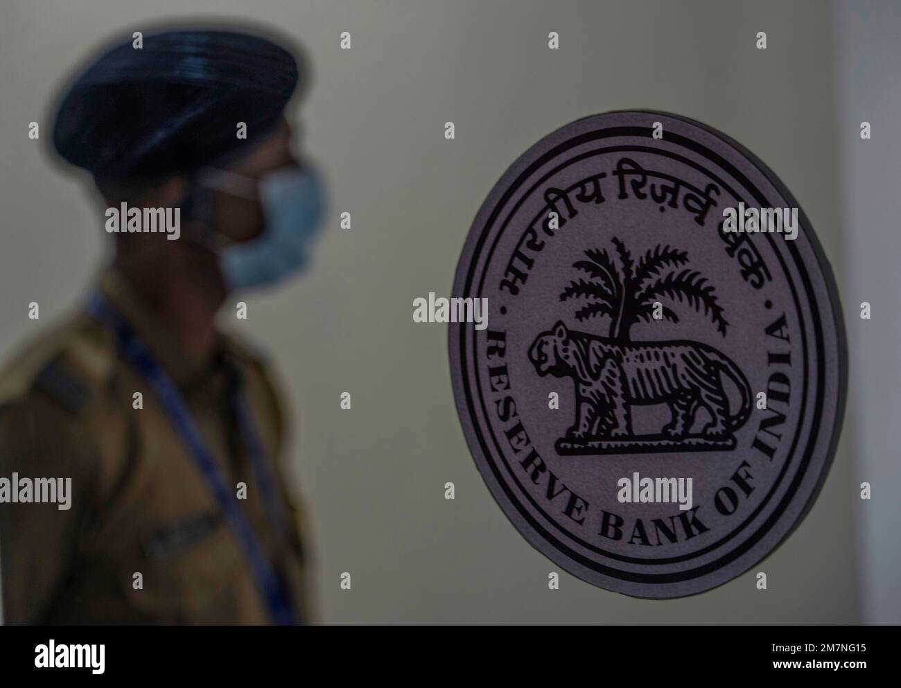 A security man stands guard near the Logo of Reserve Bank of India (RBI ...