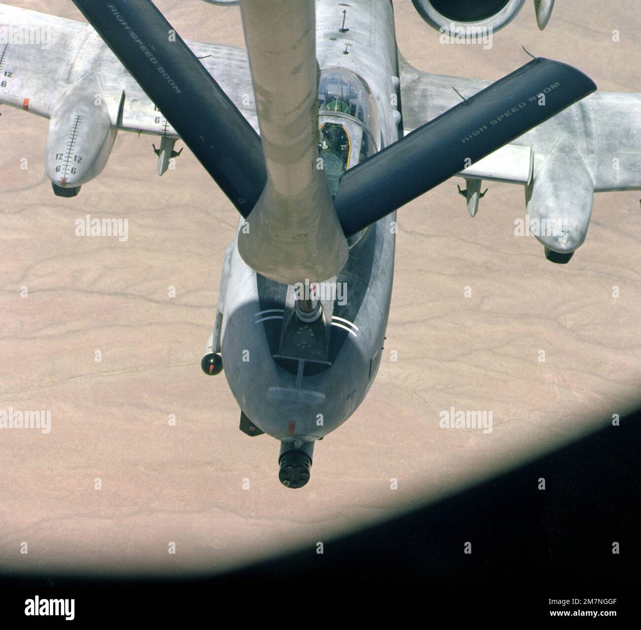 The nose of an in-flight A-10 as the aircraft is refueled through the ...