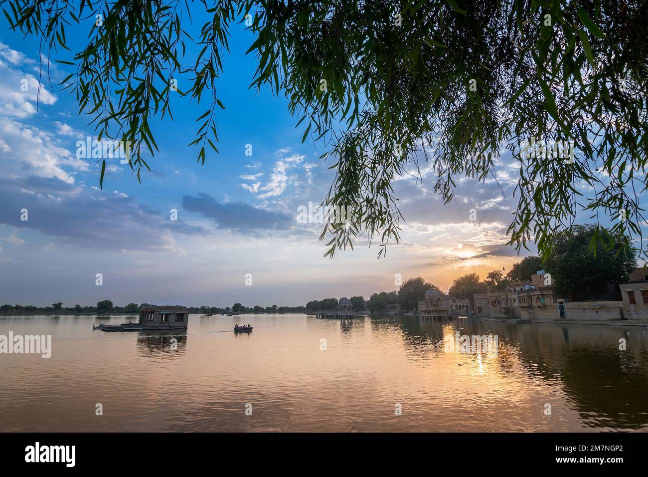 Sun sets behind main entrance of Gadisar lake, Jaisalmer, Rajasthan ...