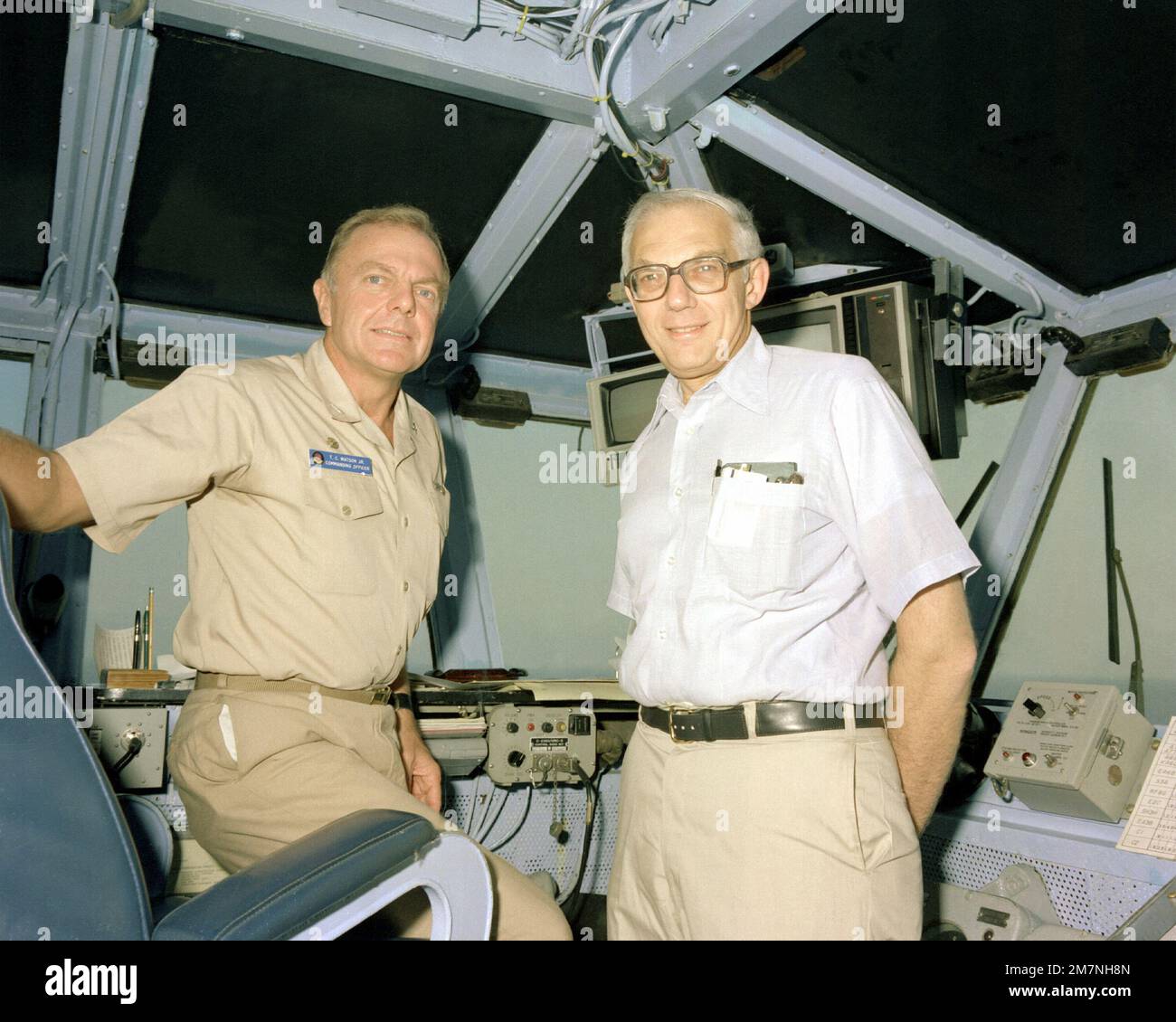 Undersecretary of the Navy David Mann, right, and CAPT Thomas C. Watson ...