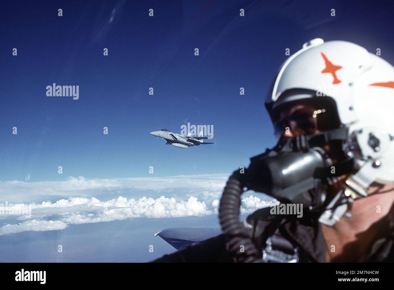 A close-up view of a photographer in the backseat of an F-15 Eagle ...
