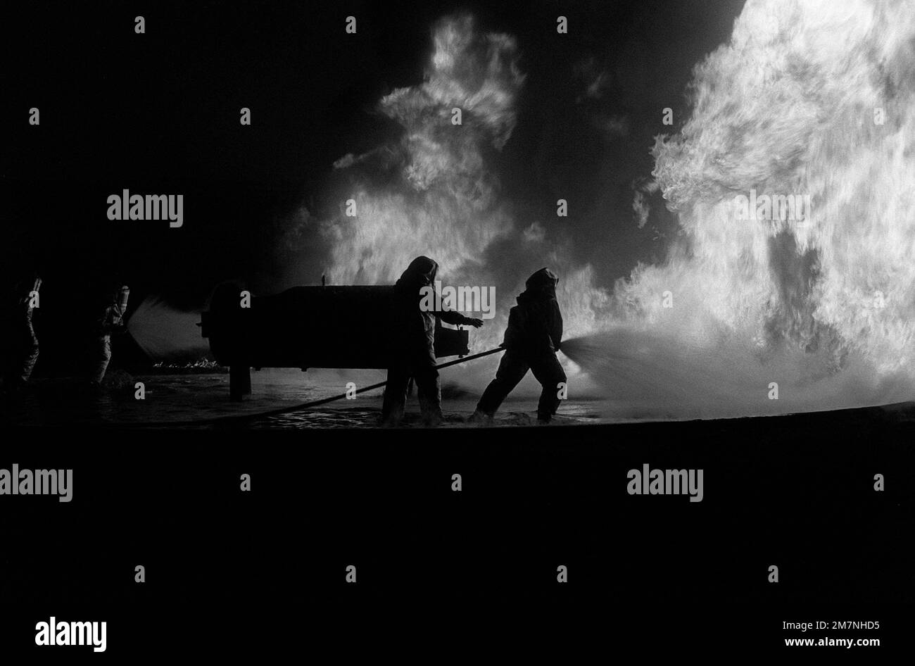 Four Marine crash crewmen undergo training in fighting an aviation fire ...