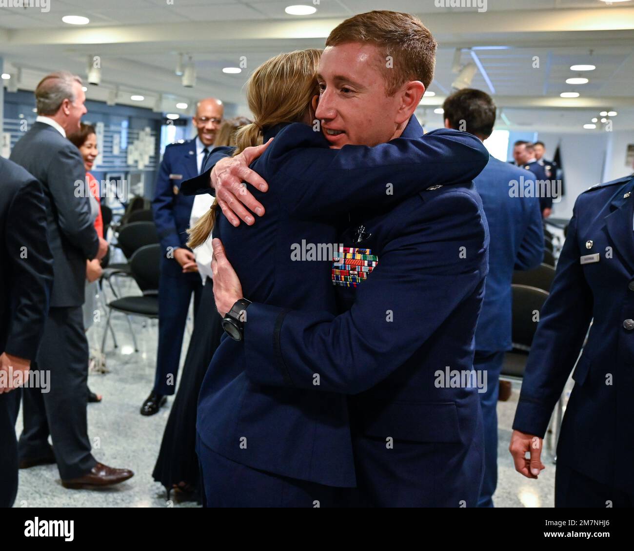 A colleague embraces Air Force Capt. Taylor Bye after a ceremony at the ...