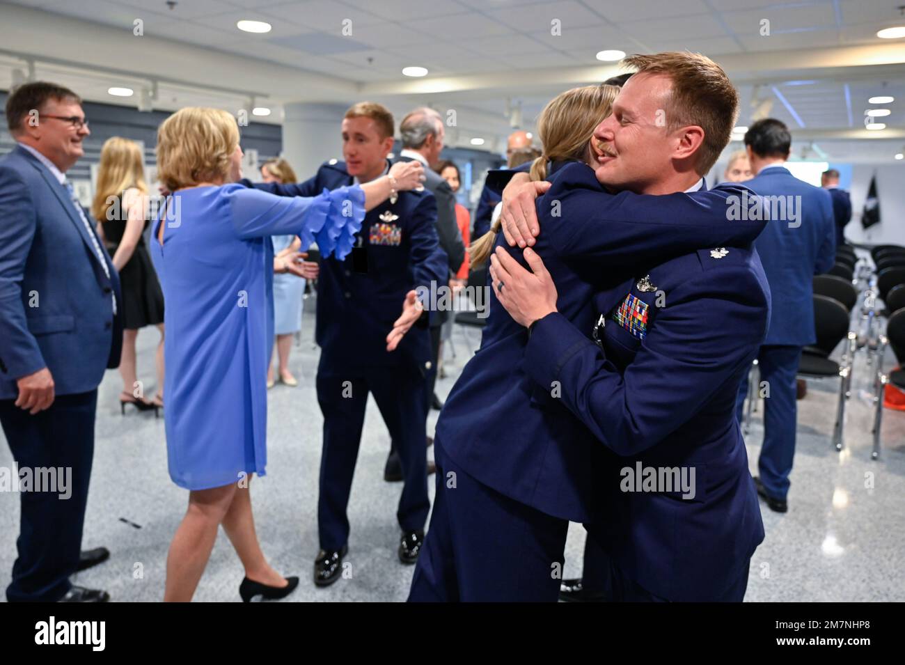 A colleague embraces Air Force Capt. Taylor Bye after a ceremony at the ...