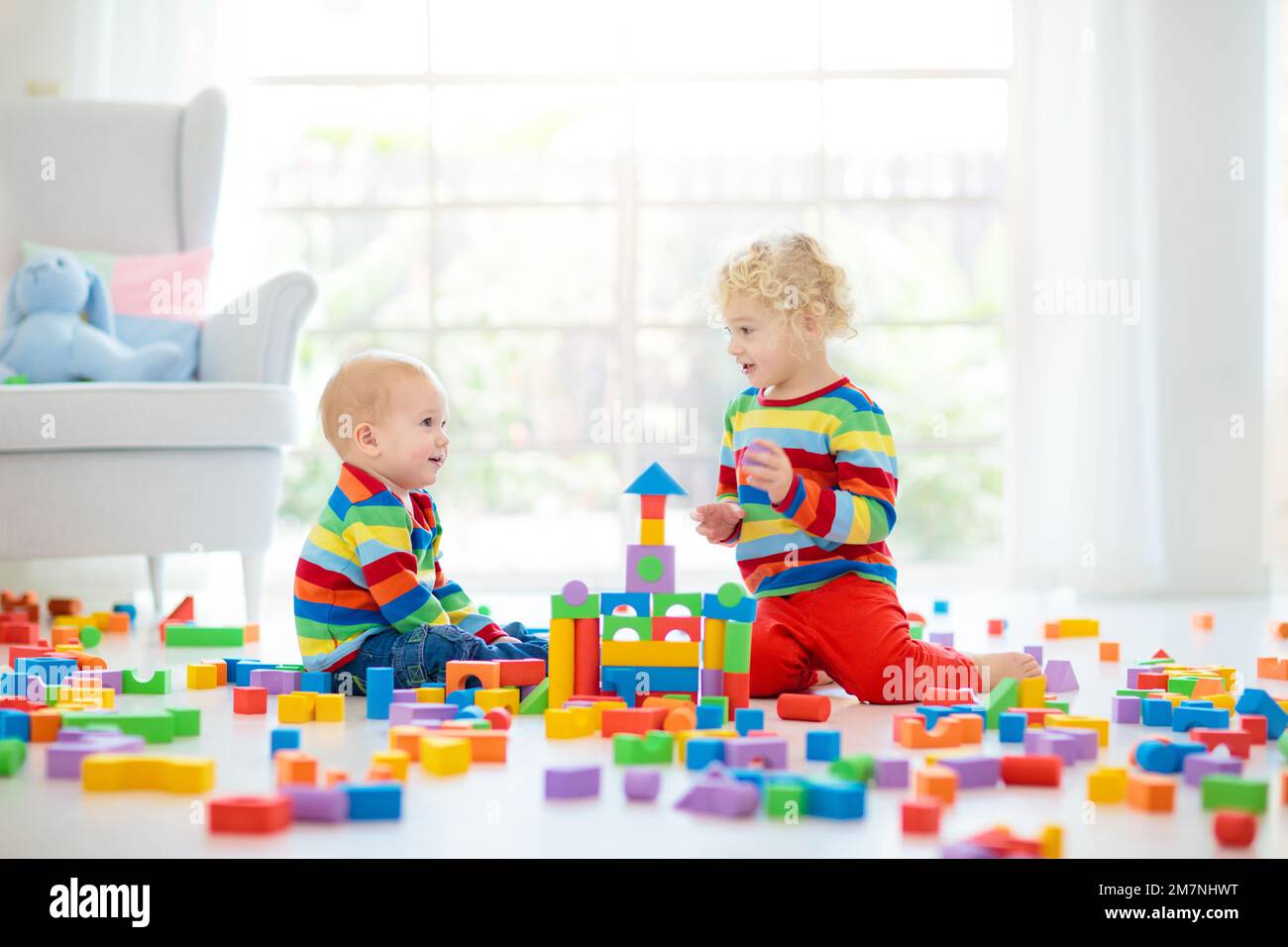 Kids play with wooden toy blocks. Educational colorful toys for ...